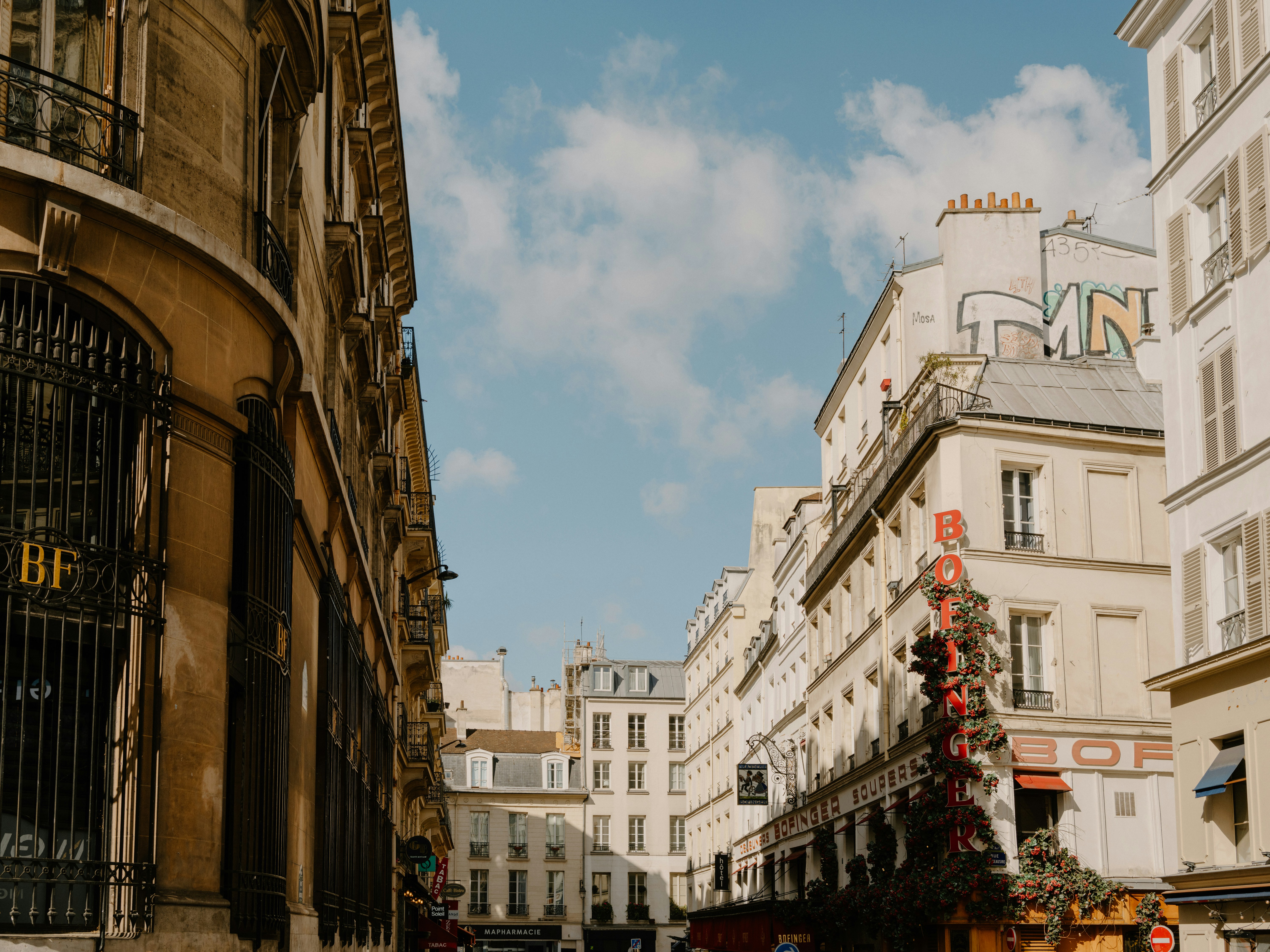 Sunlit Parisian Street Corridor with Historic Facades