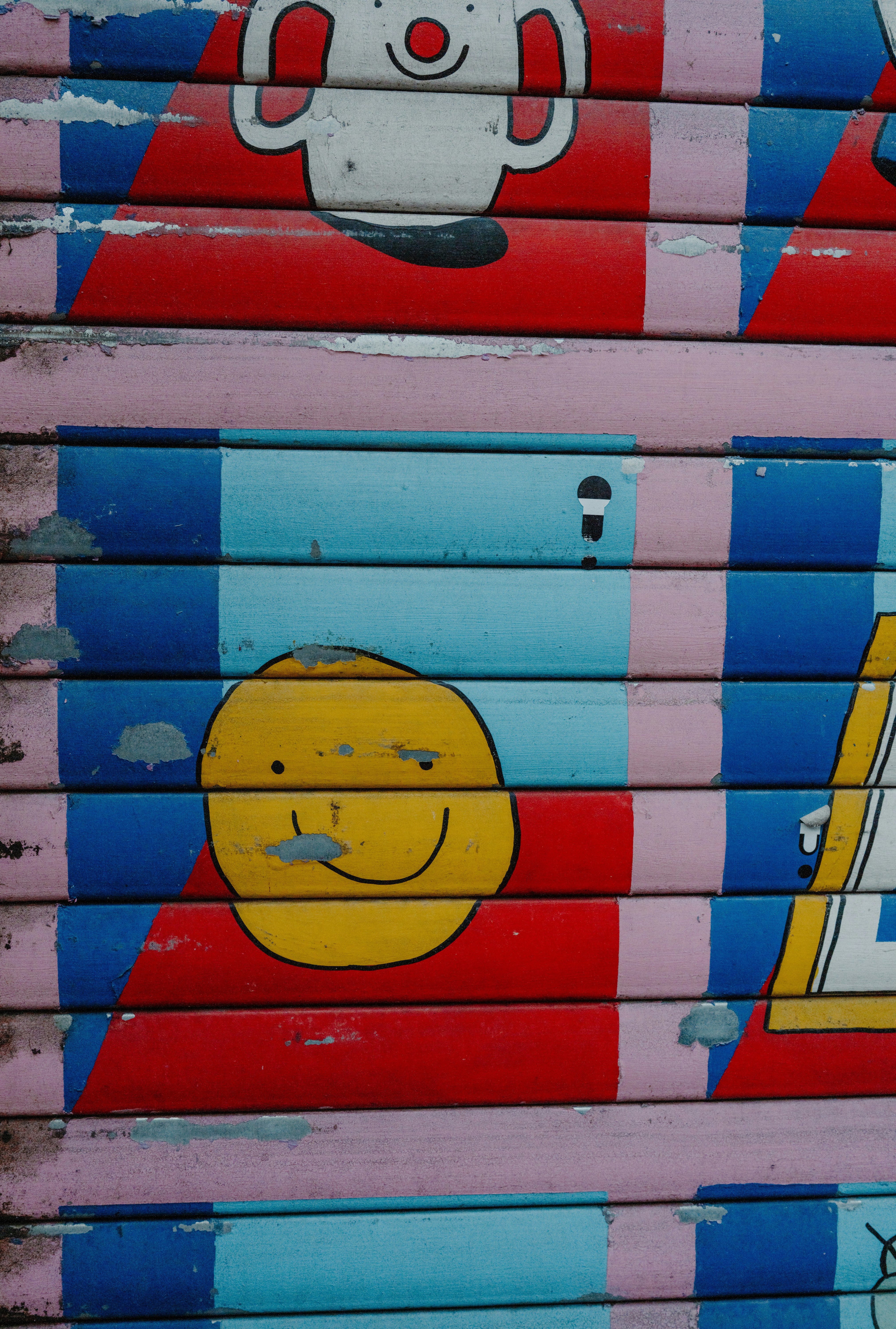 Smiling Yellow Circle Over Purple and Blue Stripes