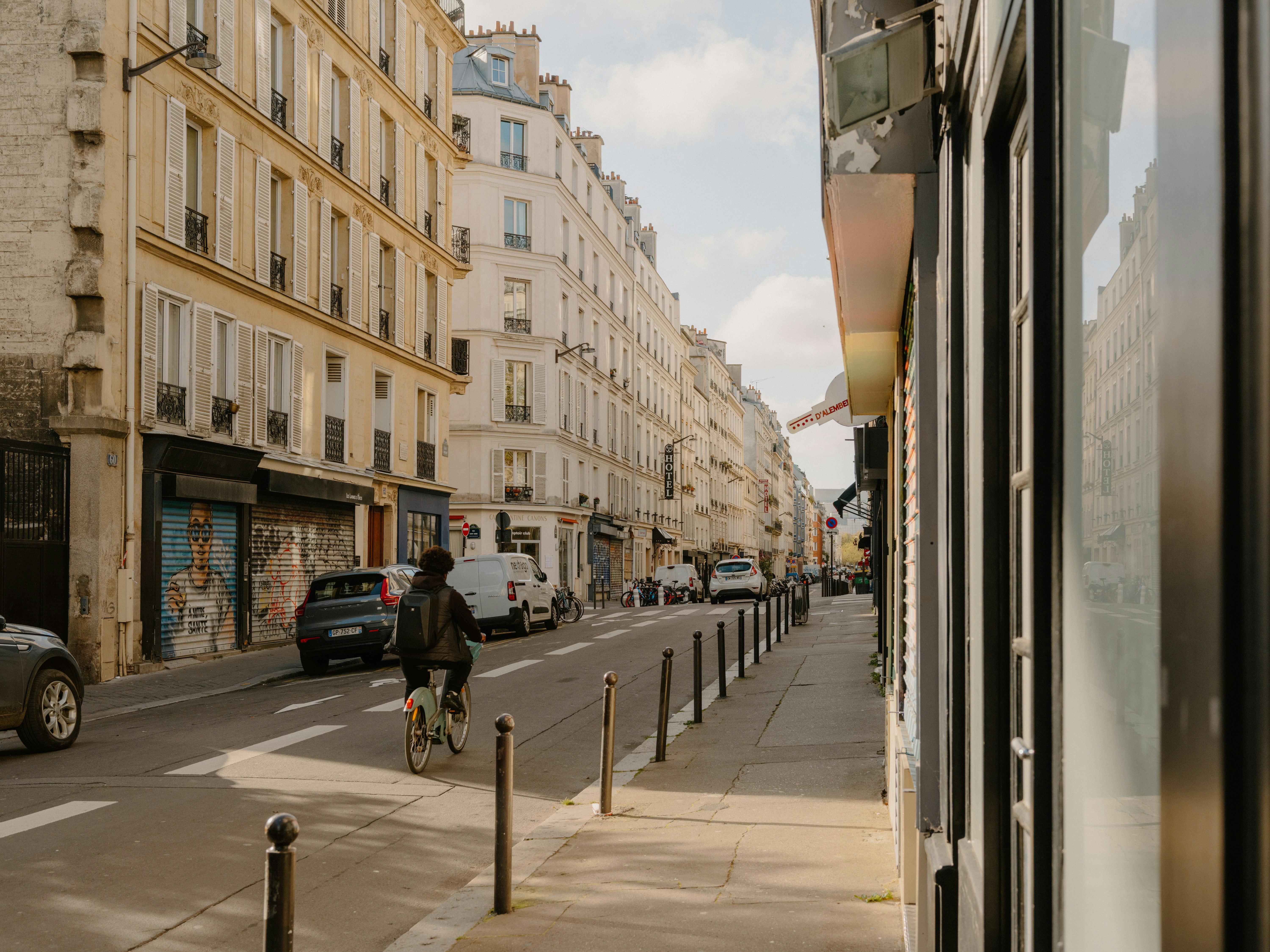 Cobbled Street Pulse: A City Awakens with a Cyclist in Flow