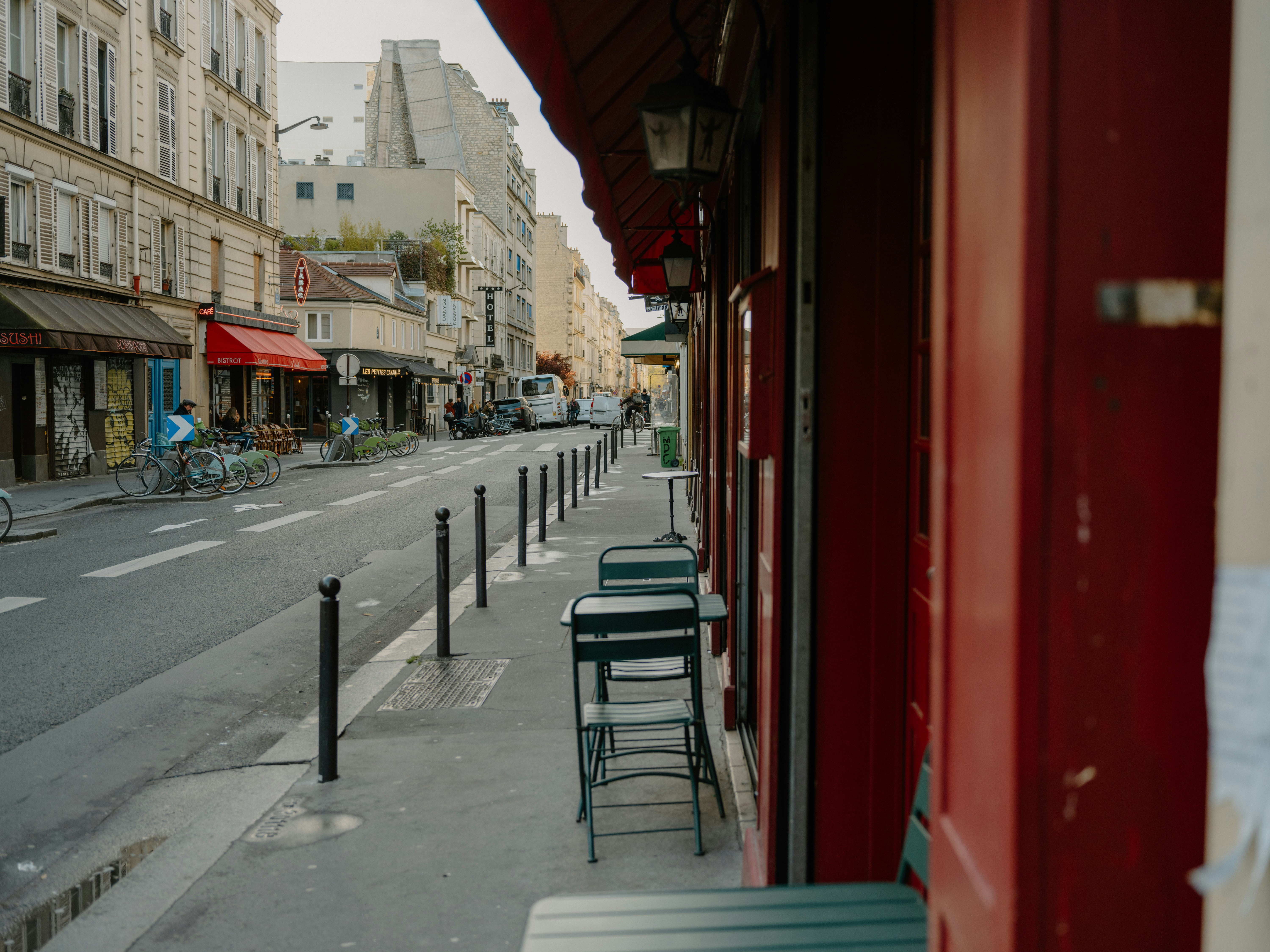 Café Row Narrowing: Chairs Waiting on a Quiet Street
