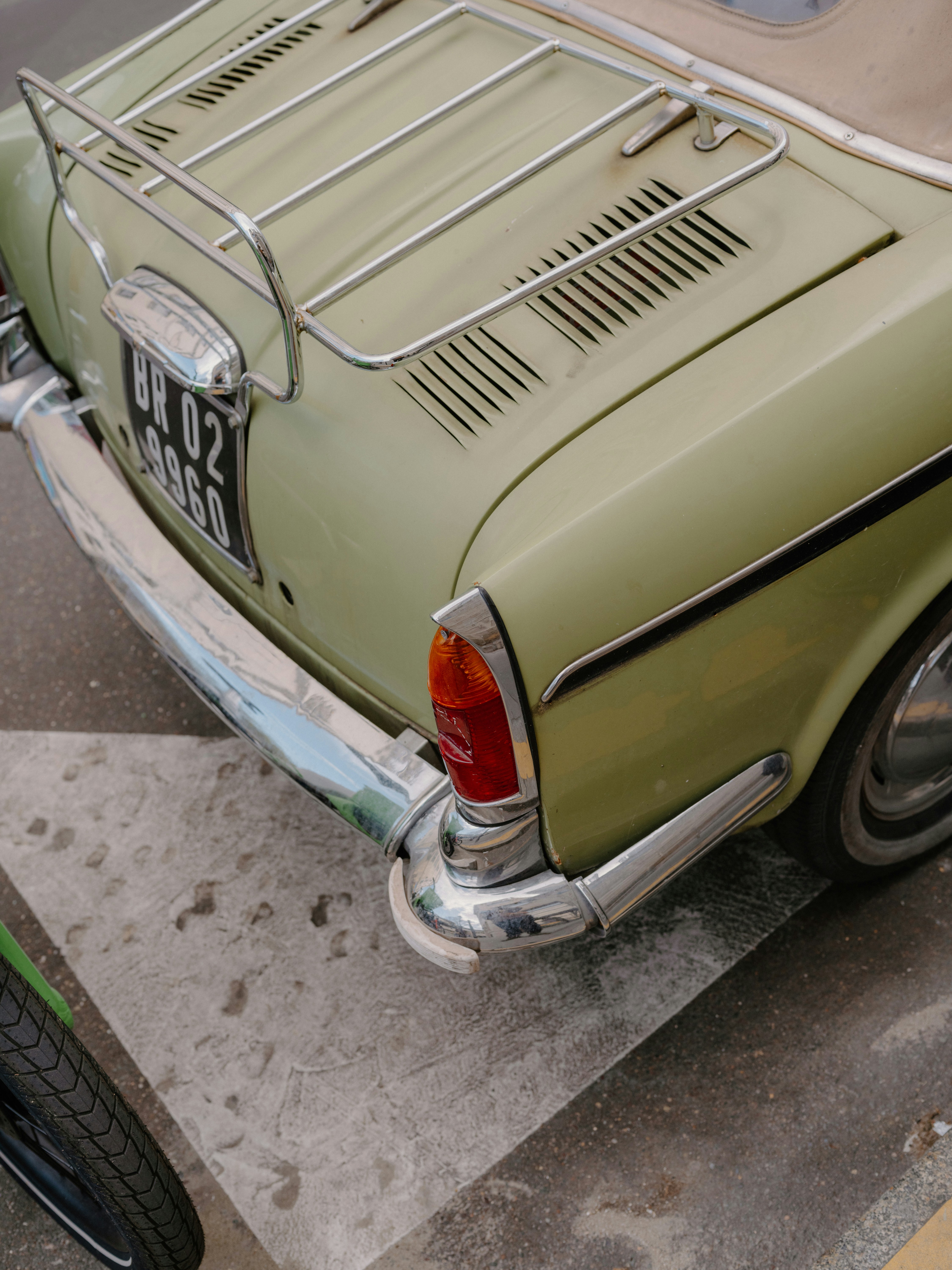 Rear Corner Vintage Olive: Chrome Bumper and License Plate Highlight
