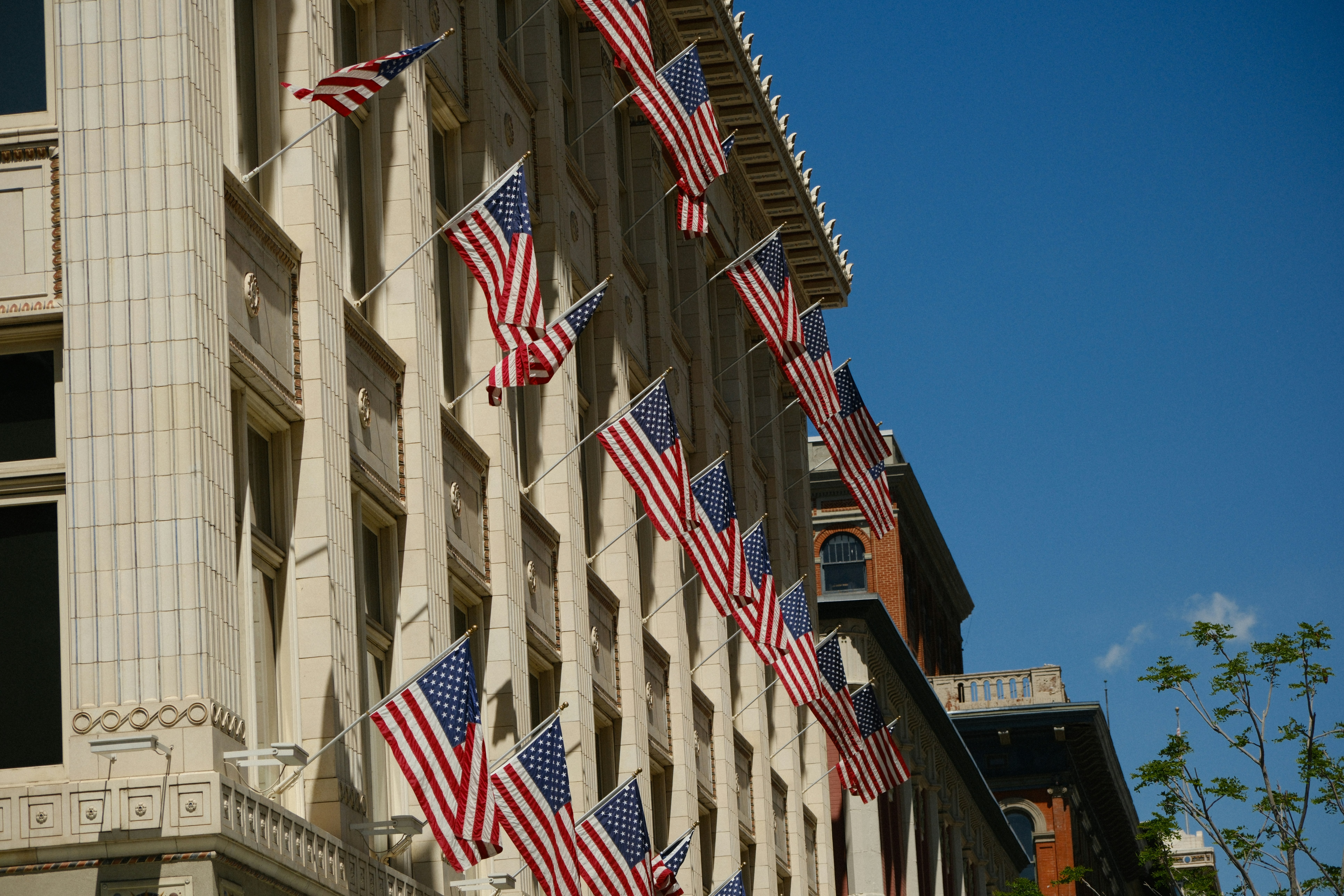 Flagged Facade: Rows of Stars and Stripes Along a Historic Street