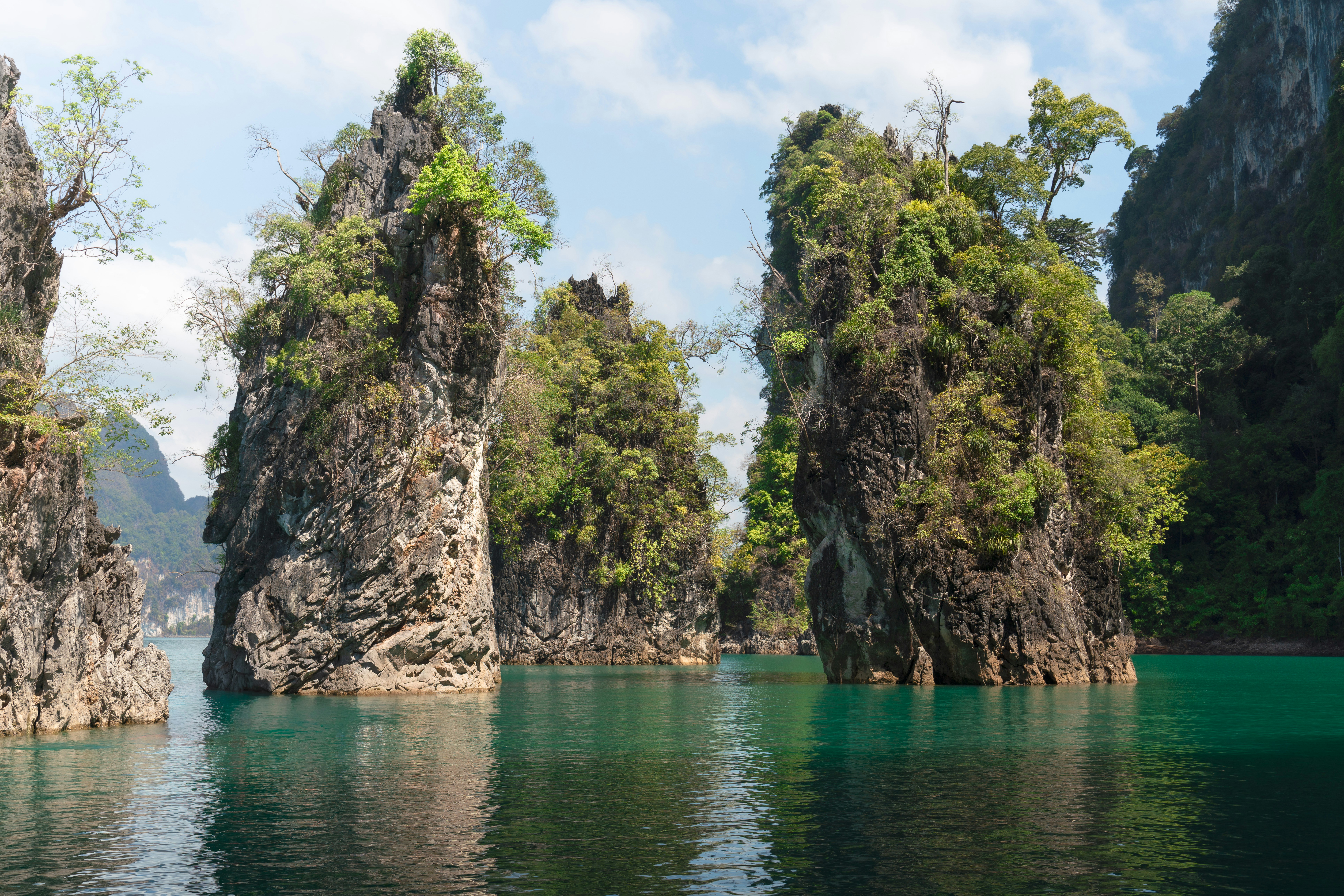 Verdant Kilns Rising from Serene Emerald Waters
