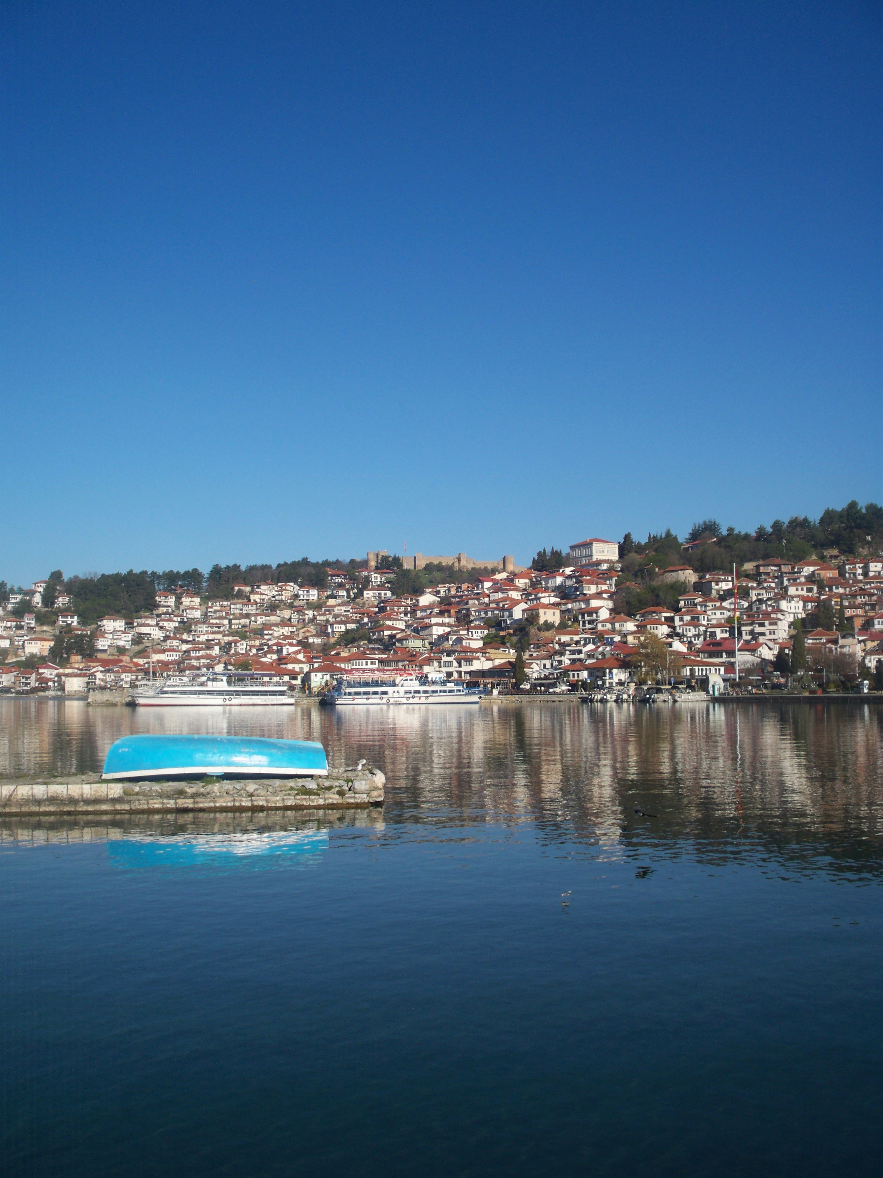 Blue-Boat Harbor Under a Clear Coastal Sky