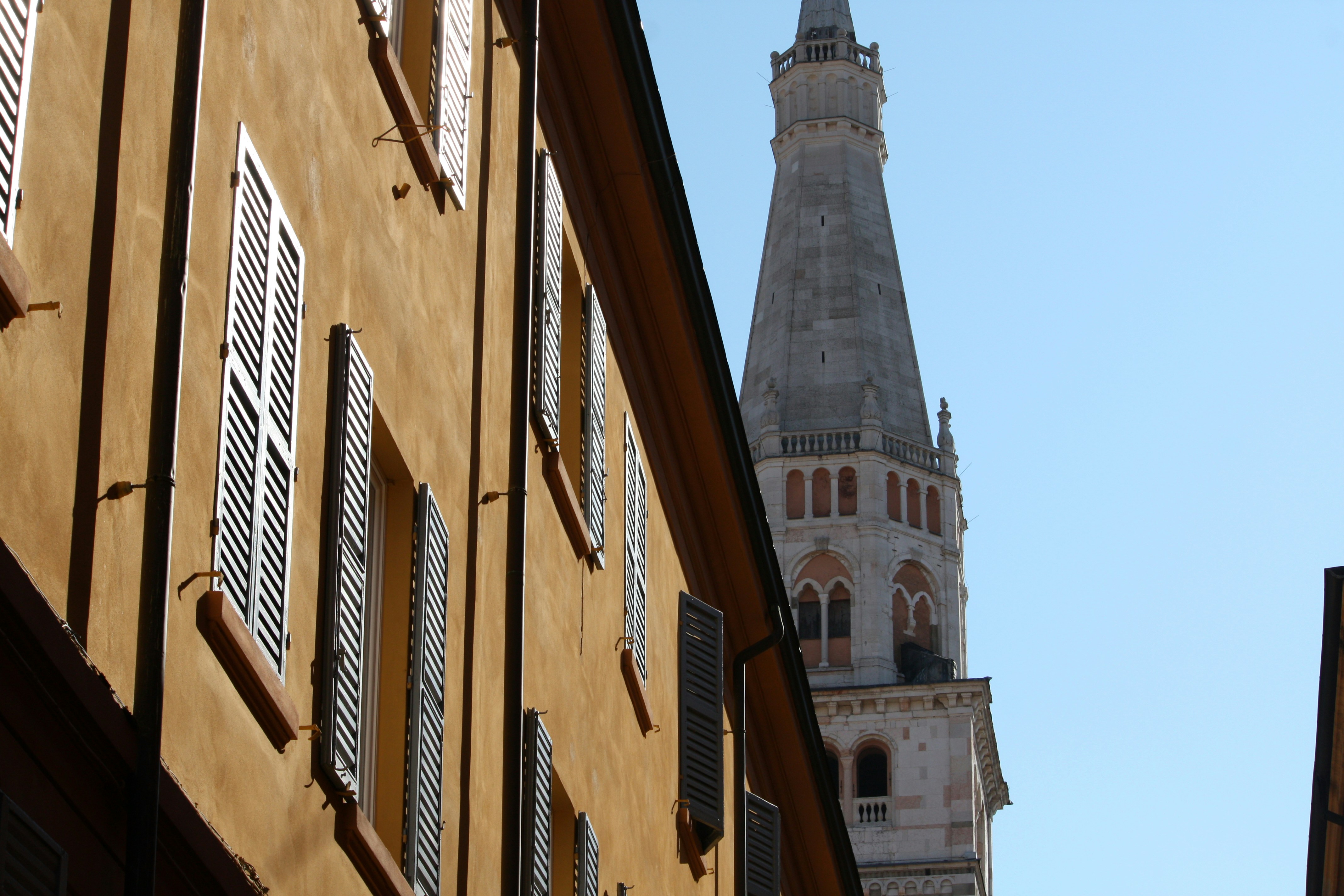 Sunlit Arcades and Bell Tower: Italian Street Composition