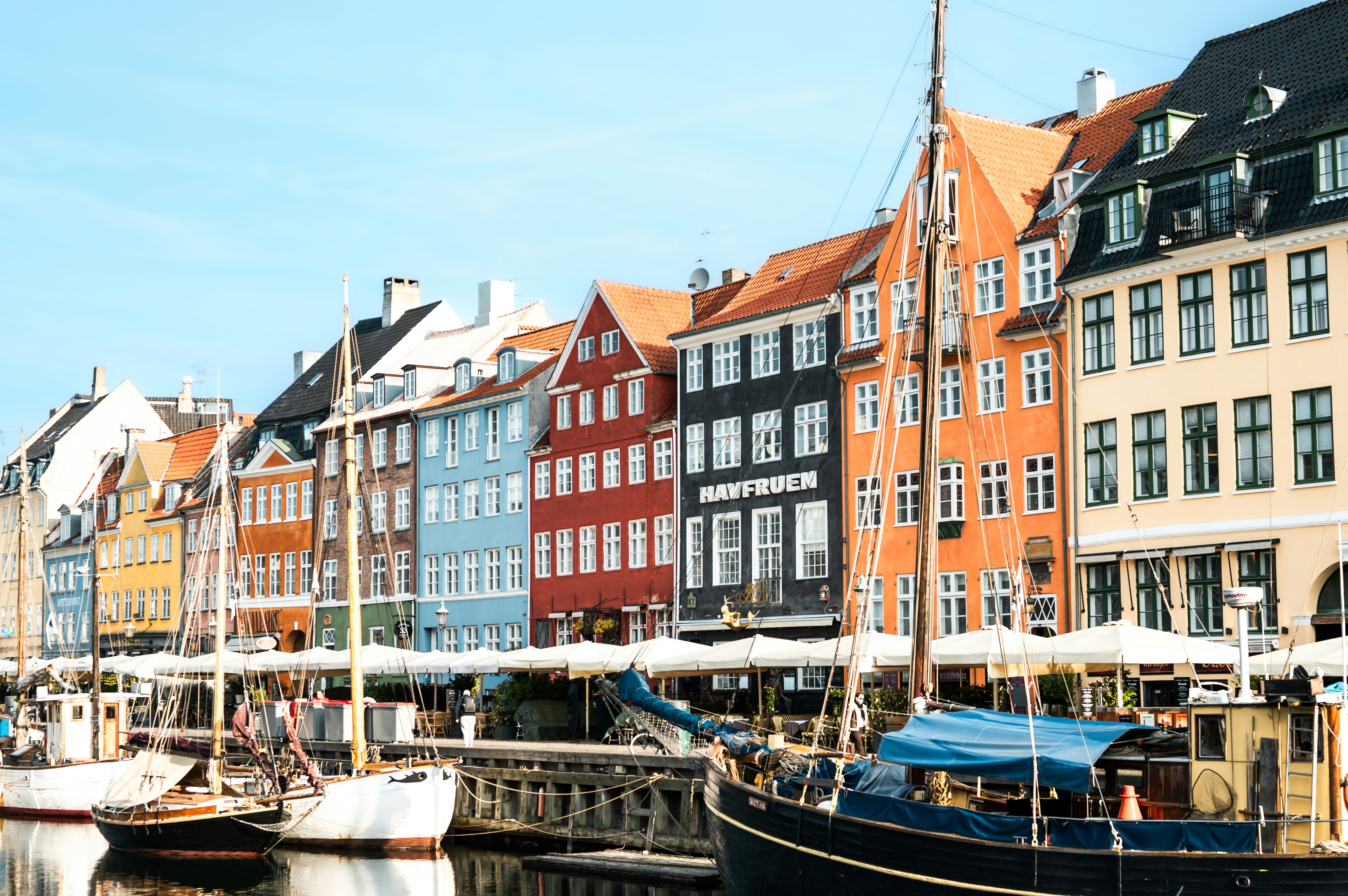 Colorful Riverside Rows: Boats and Townhouses on a Sunny harbor