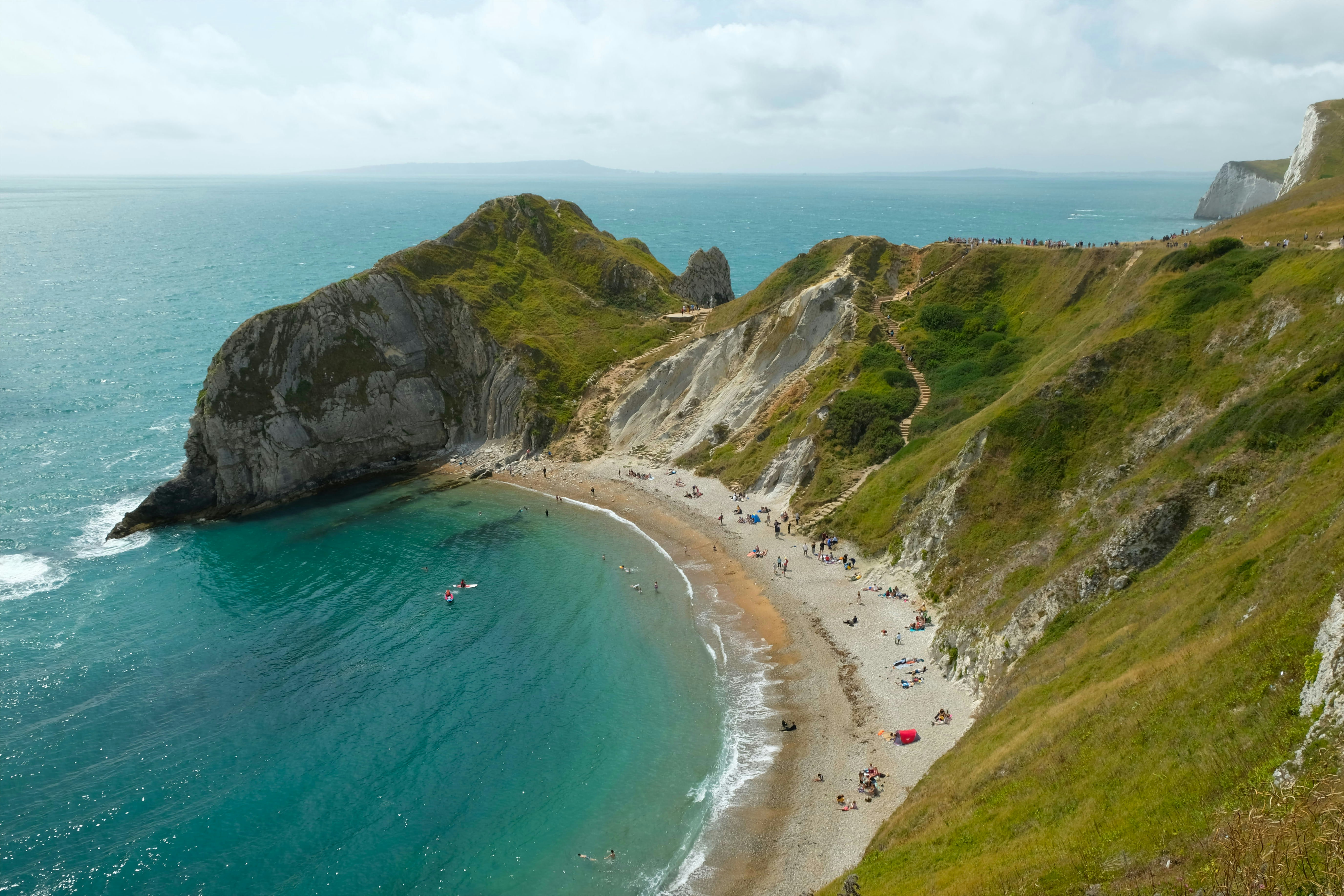 Sea-carved cliffs and crescent beach under sweeping Atlantic light