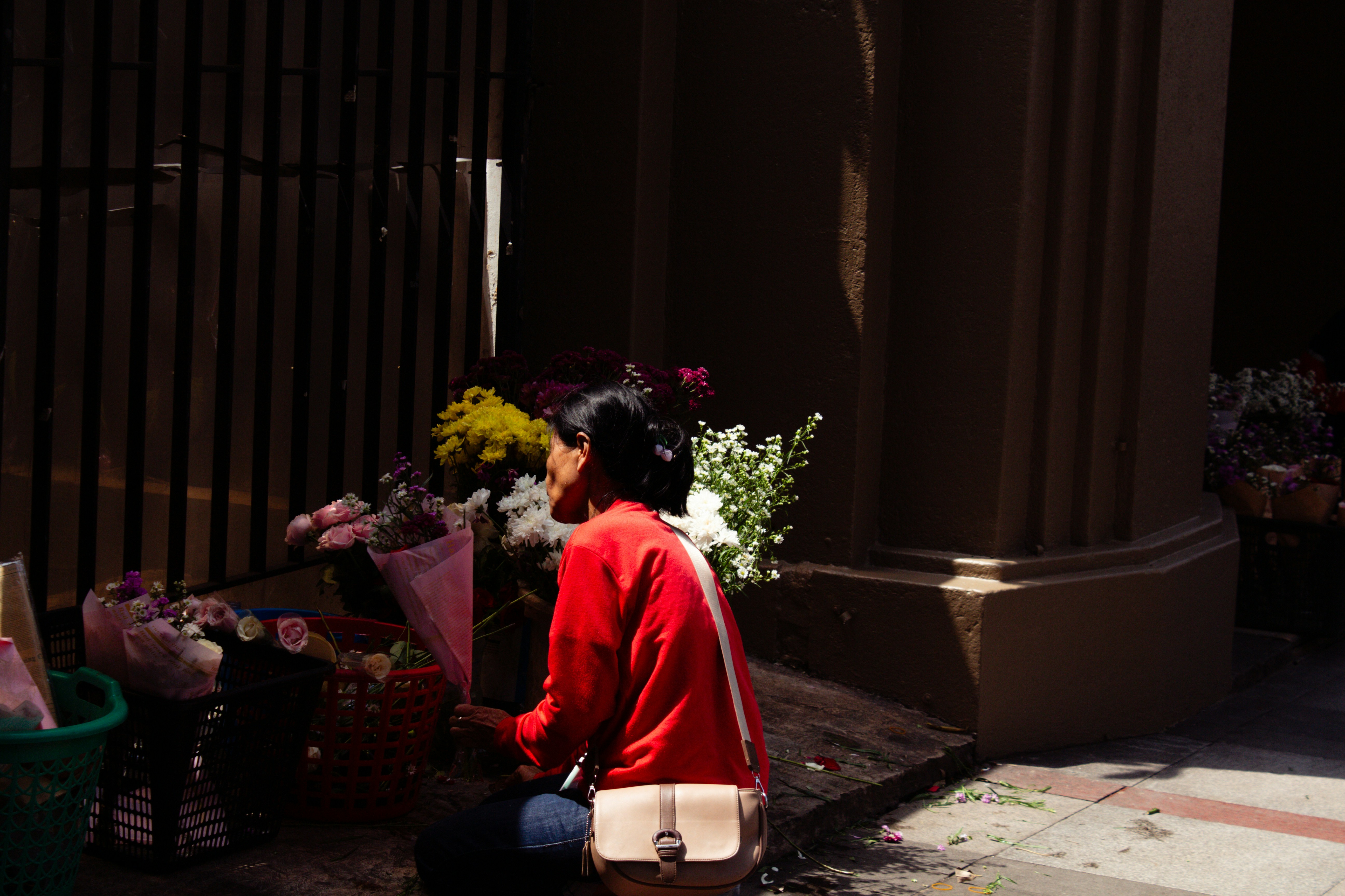 Quiet Vendor Portrait in a Sunlit Alley