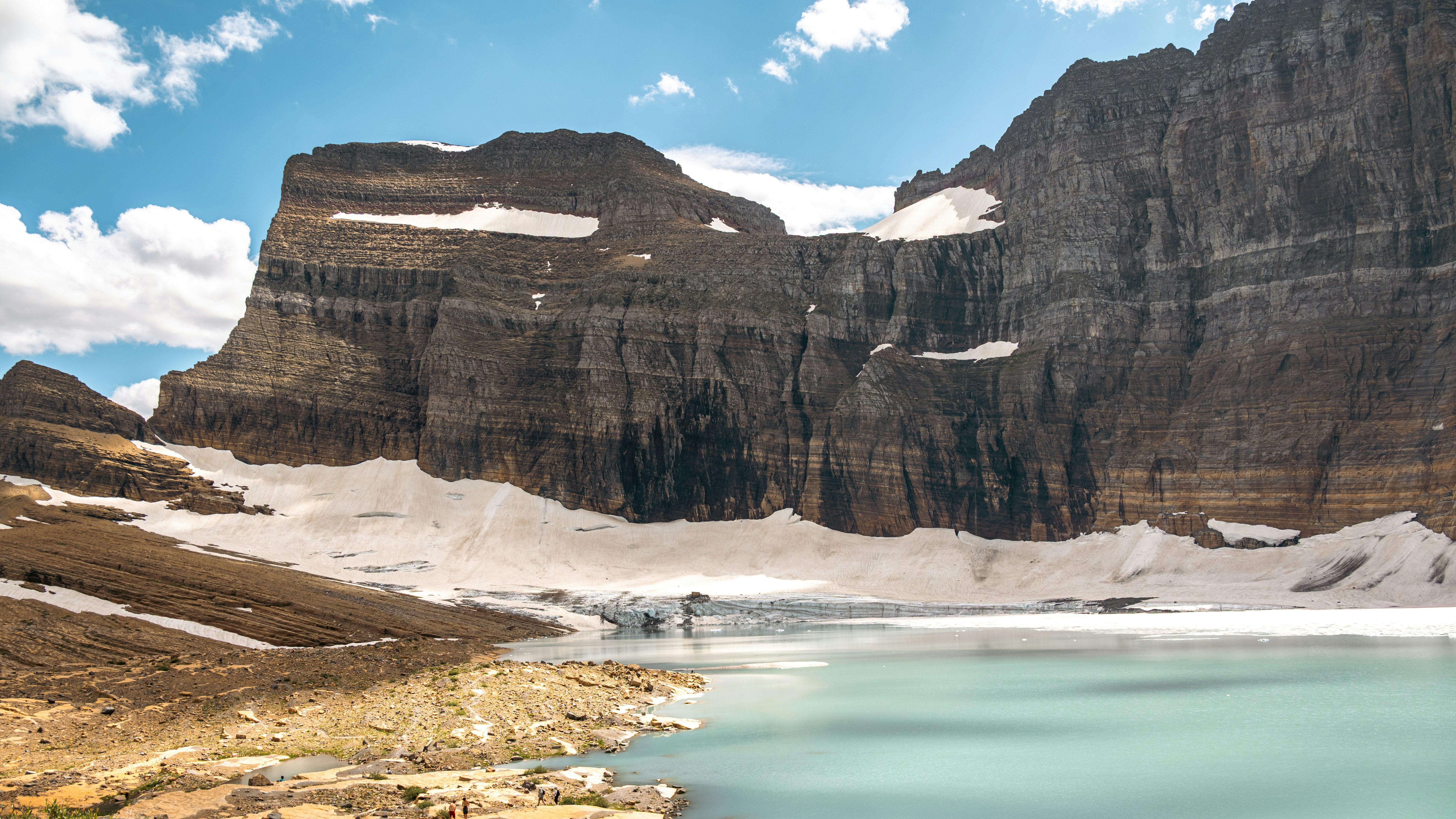 Azure Glacial Basin Under Snowbound Cliffs