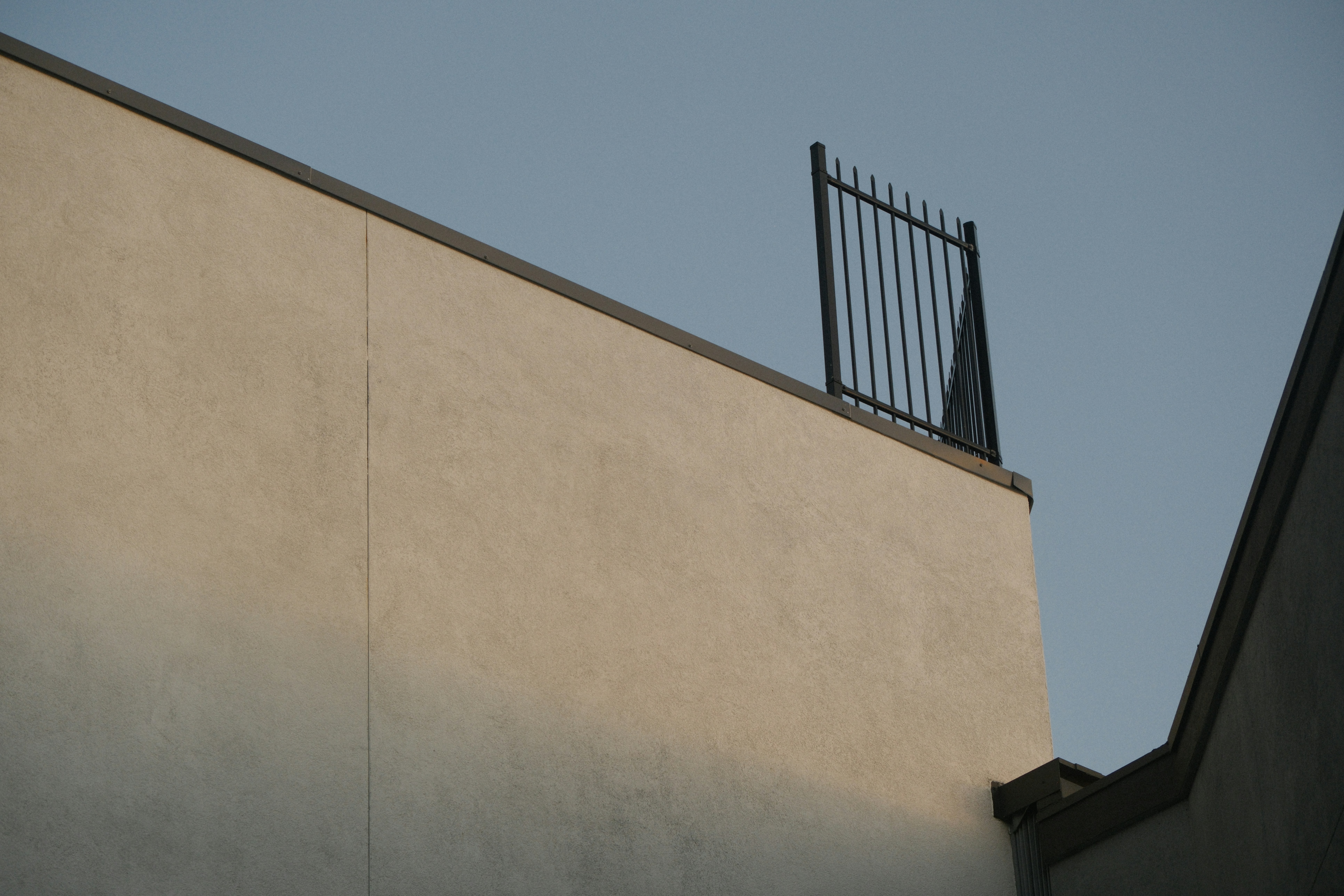 Rooftop Railing Cast Against Clear Sky