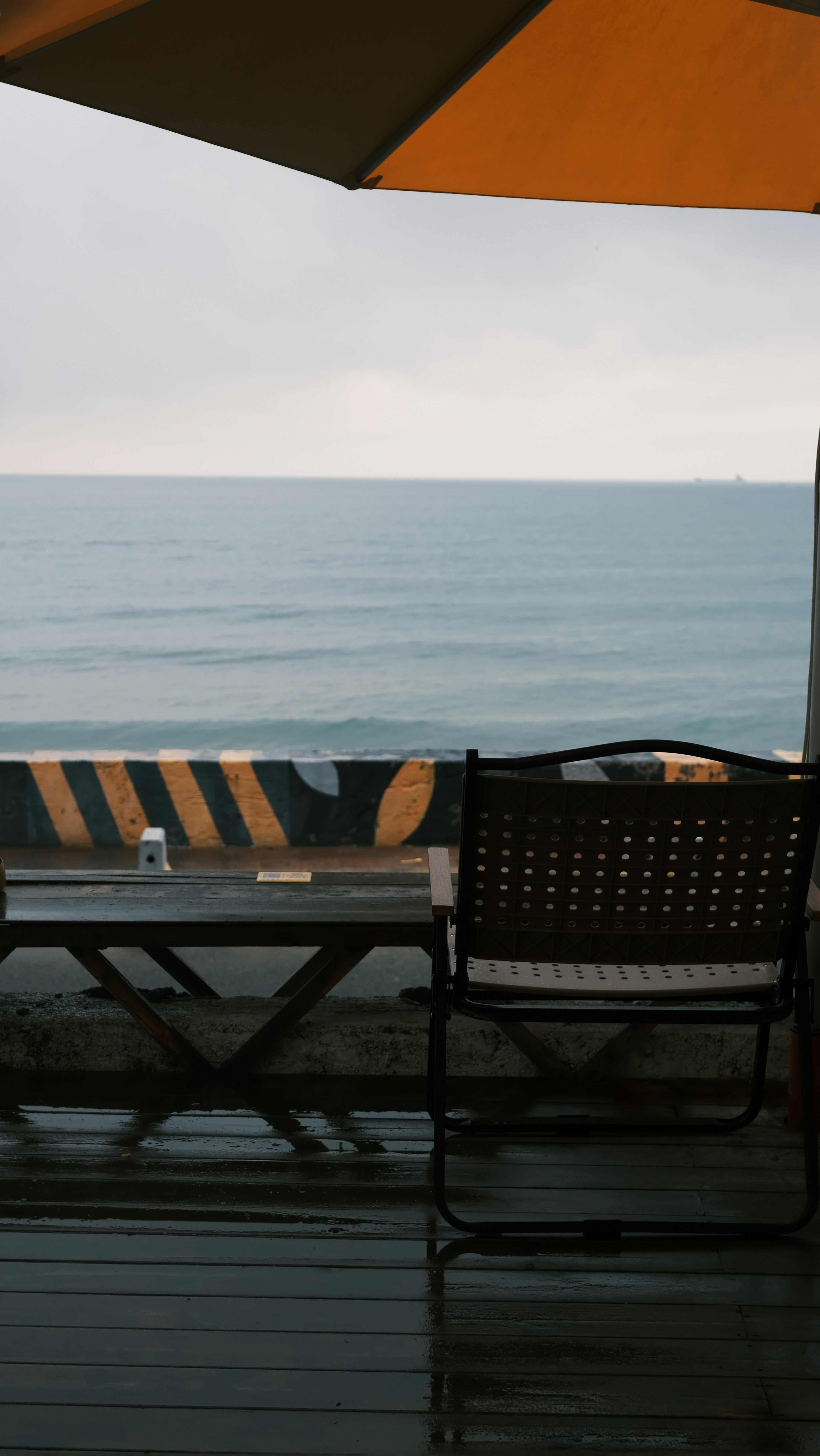 Shaded Teak Over Ocean: A Quiet Moment on the Deck