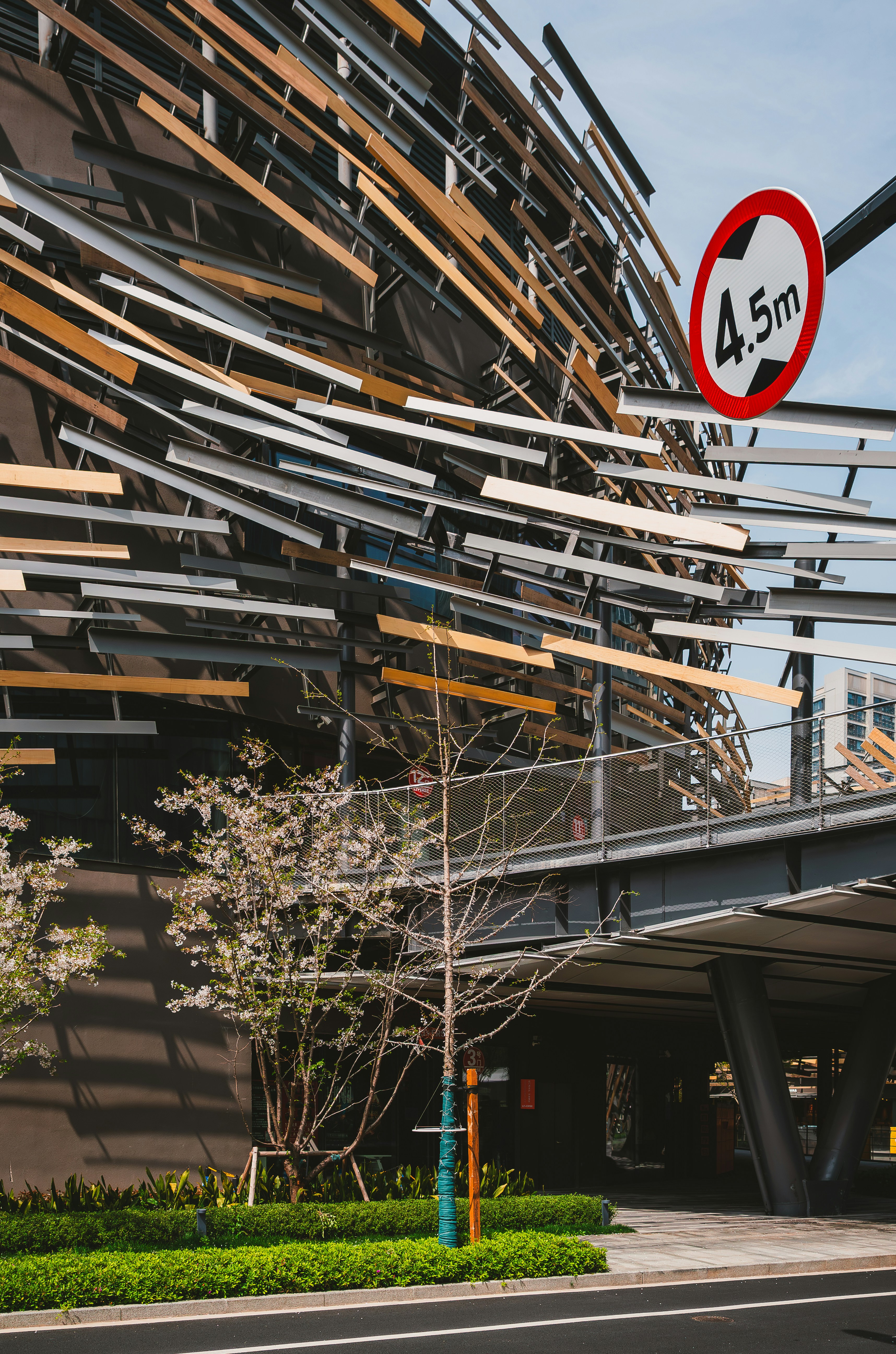 Wind-Sculpted Facade: Strips of Light and Steel Framing a City Path