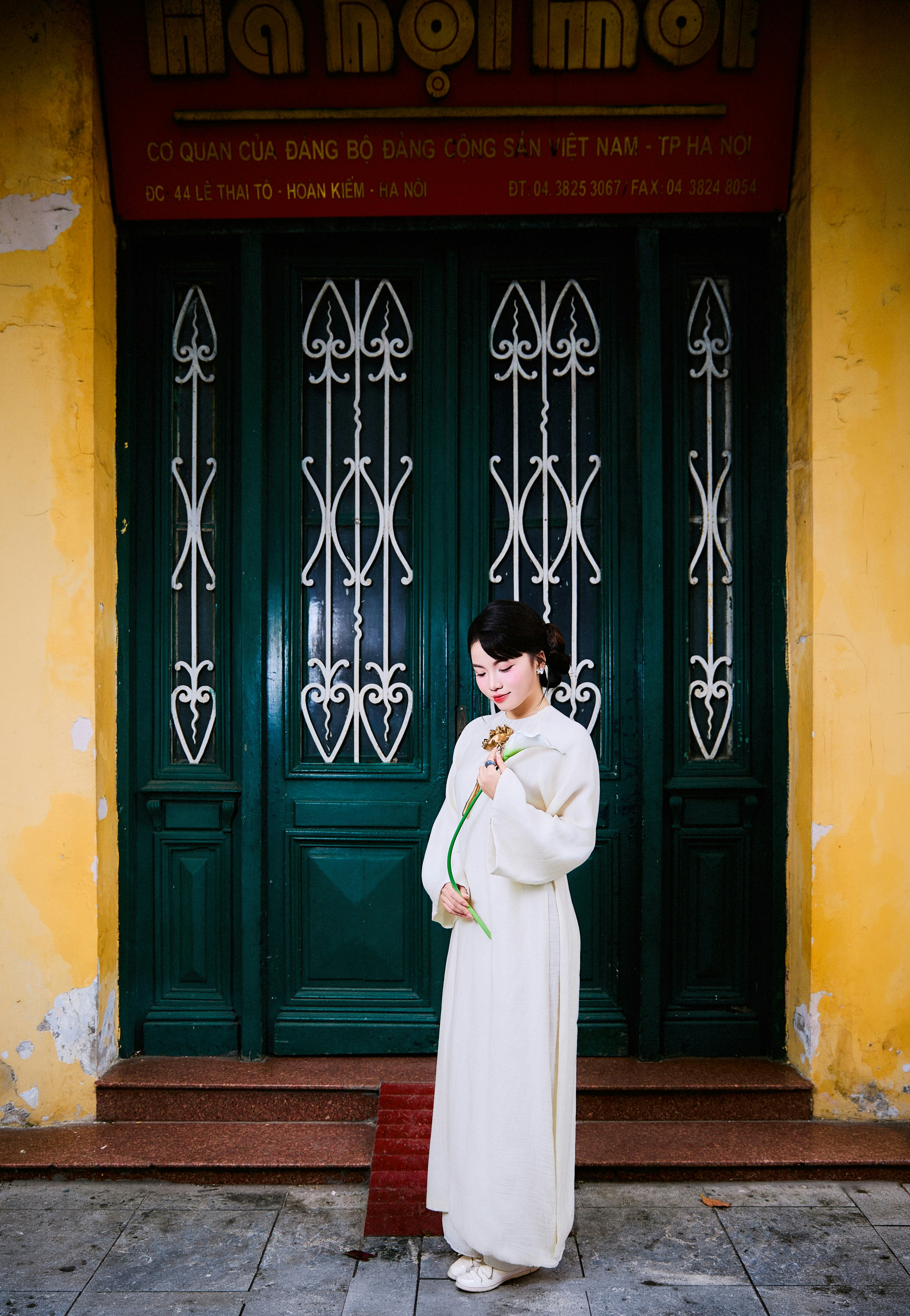 Portrait of Quiet Grace in Front of Ornate Green Gates