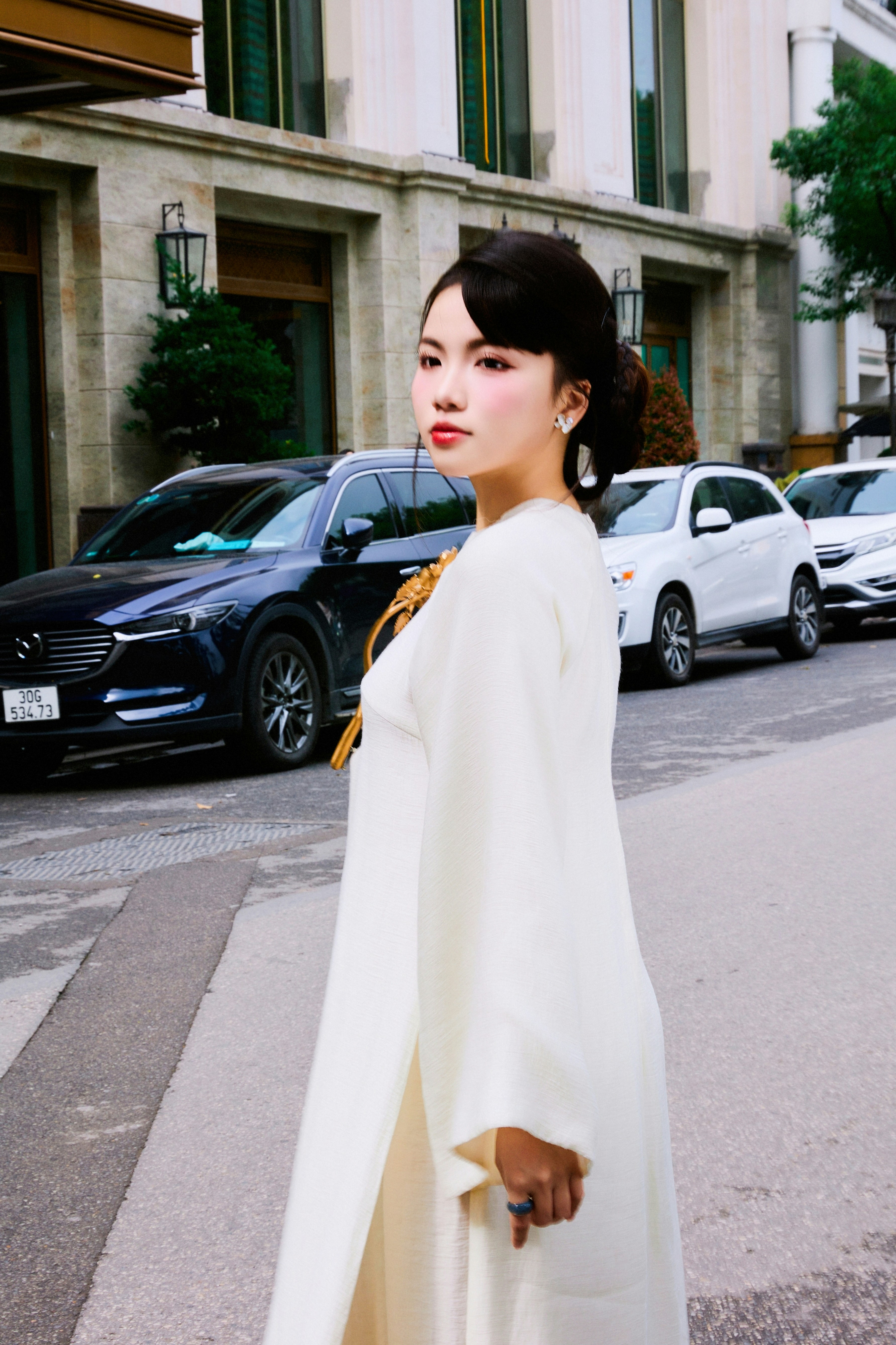 Portrait on a City Street: Elegance Among Cars