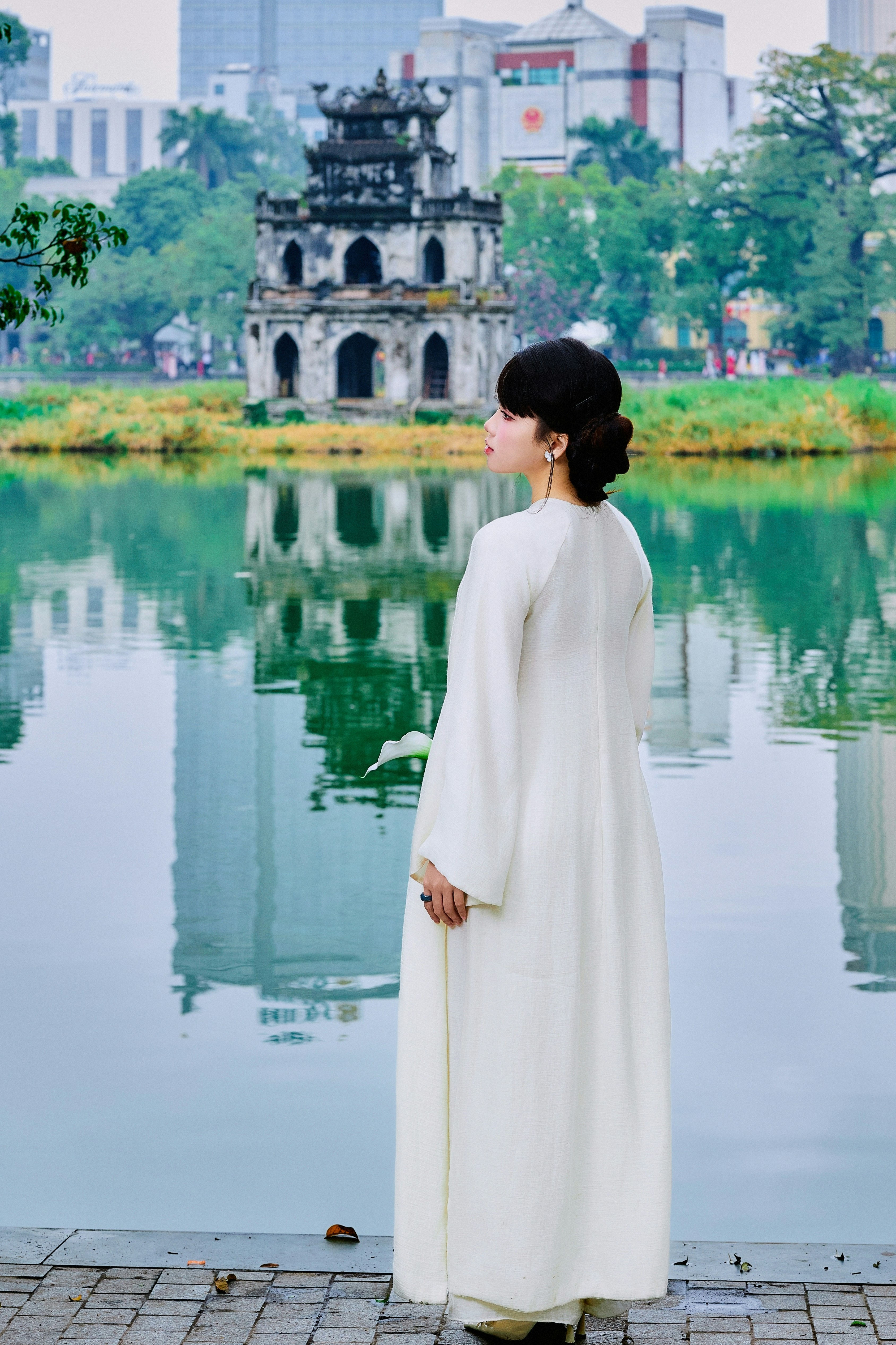 Elegance by the Lake: The White Dress and the Ancient Pavilion