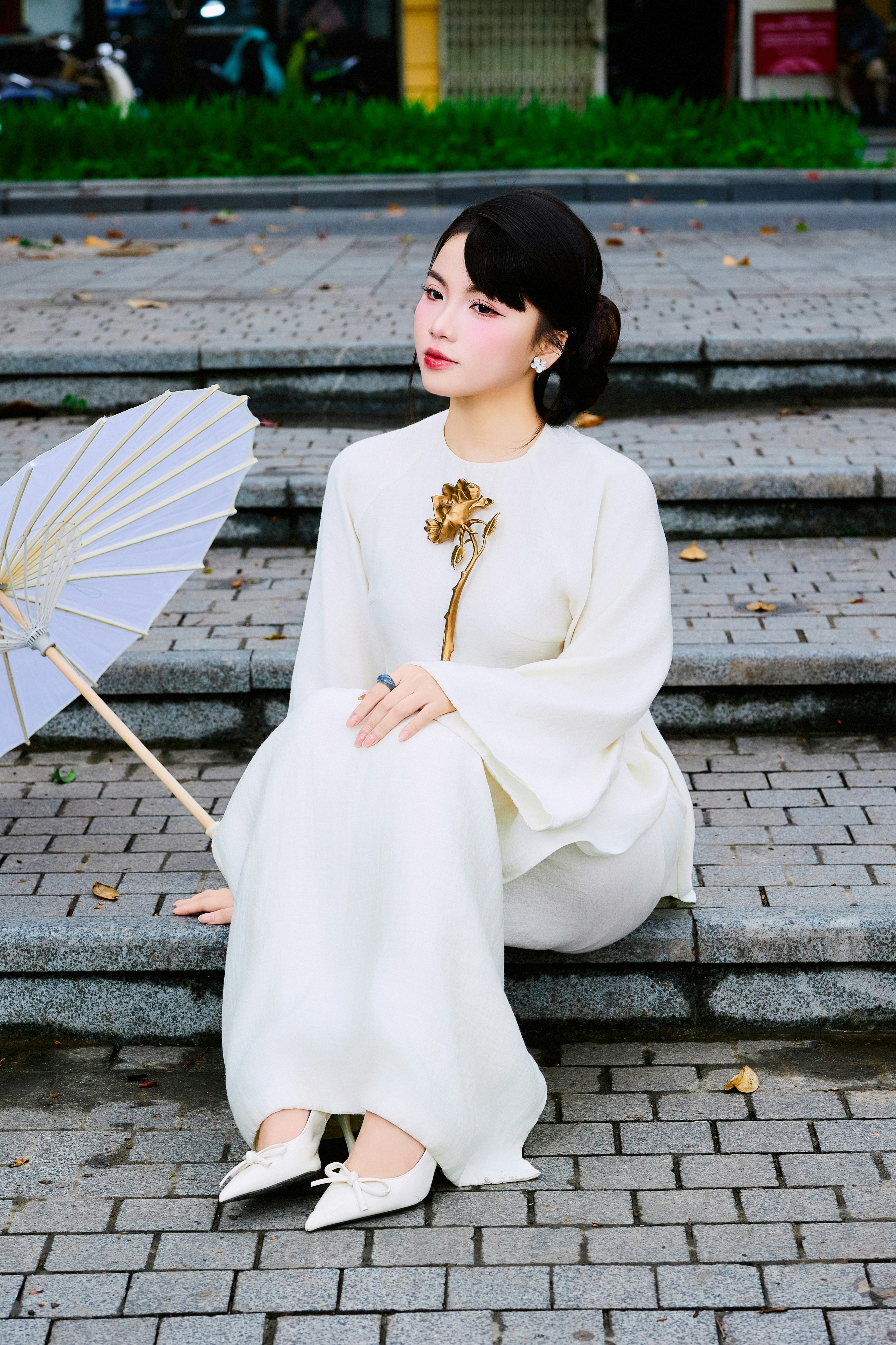 Portrait on Stone Steps: Poised in White with a Paper Umbrella