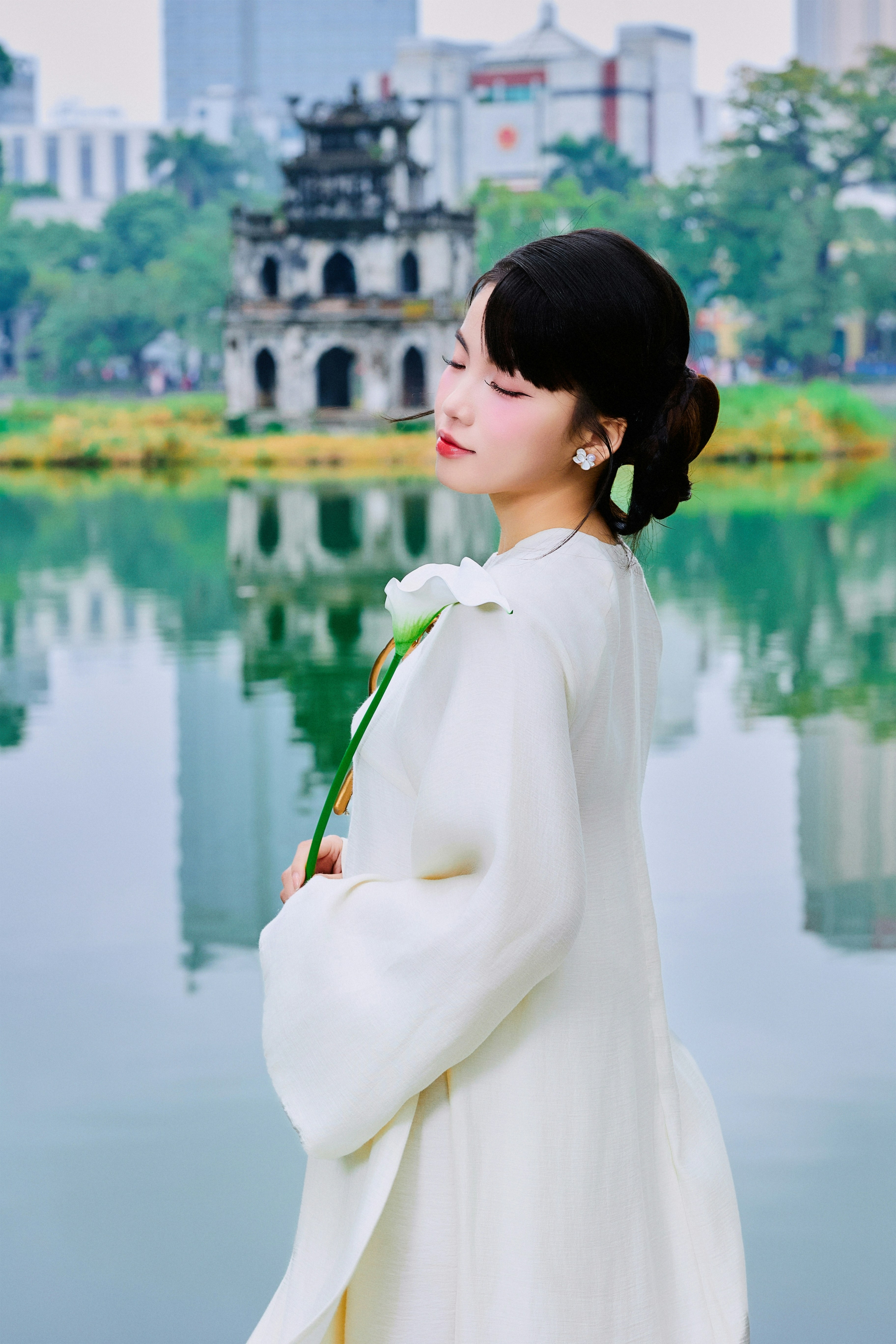 Portrait of Quiet Grace by the Water with a Temple Backdrop
