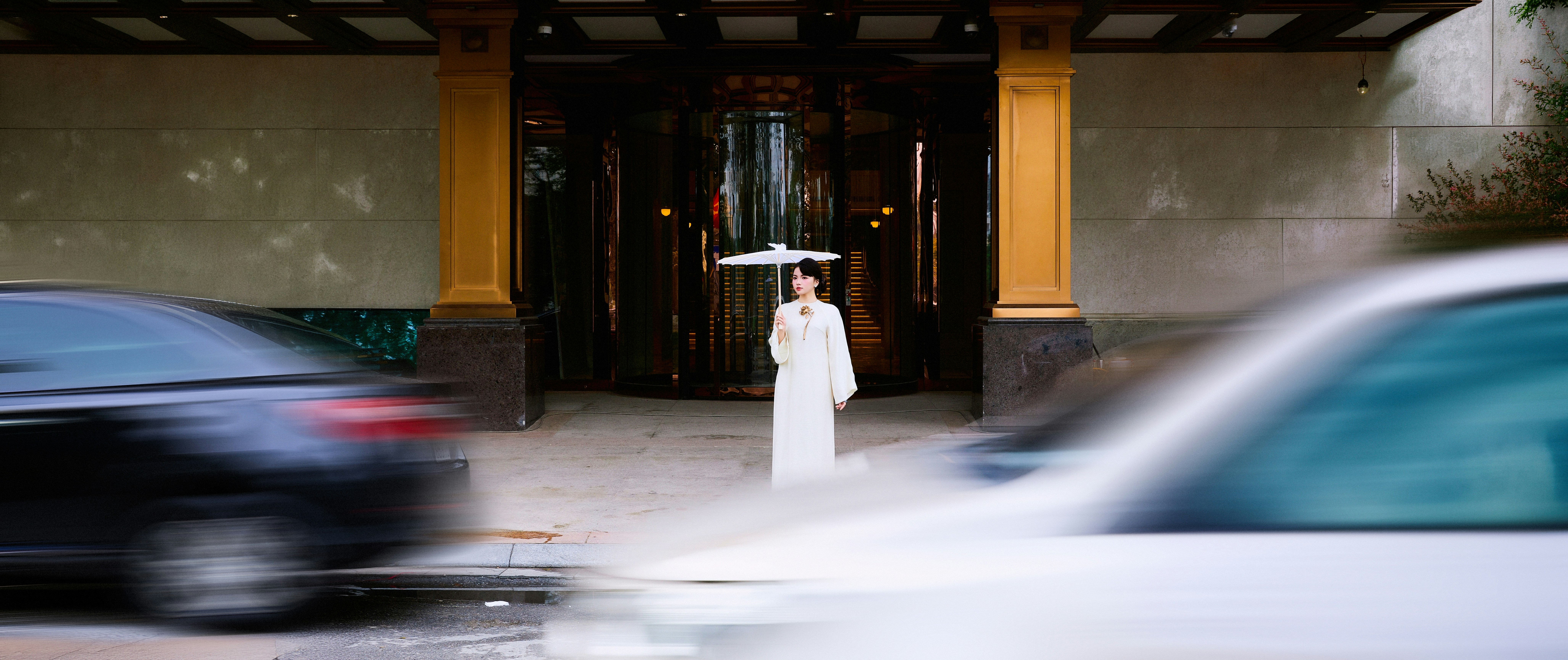 Bride in a Quiet Corridor: White Gown Amid Moving Traffic