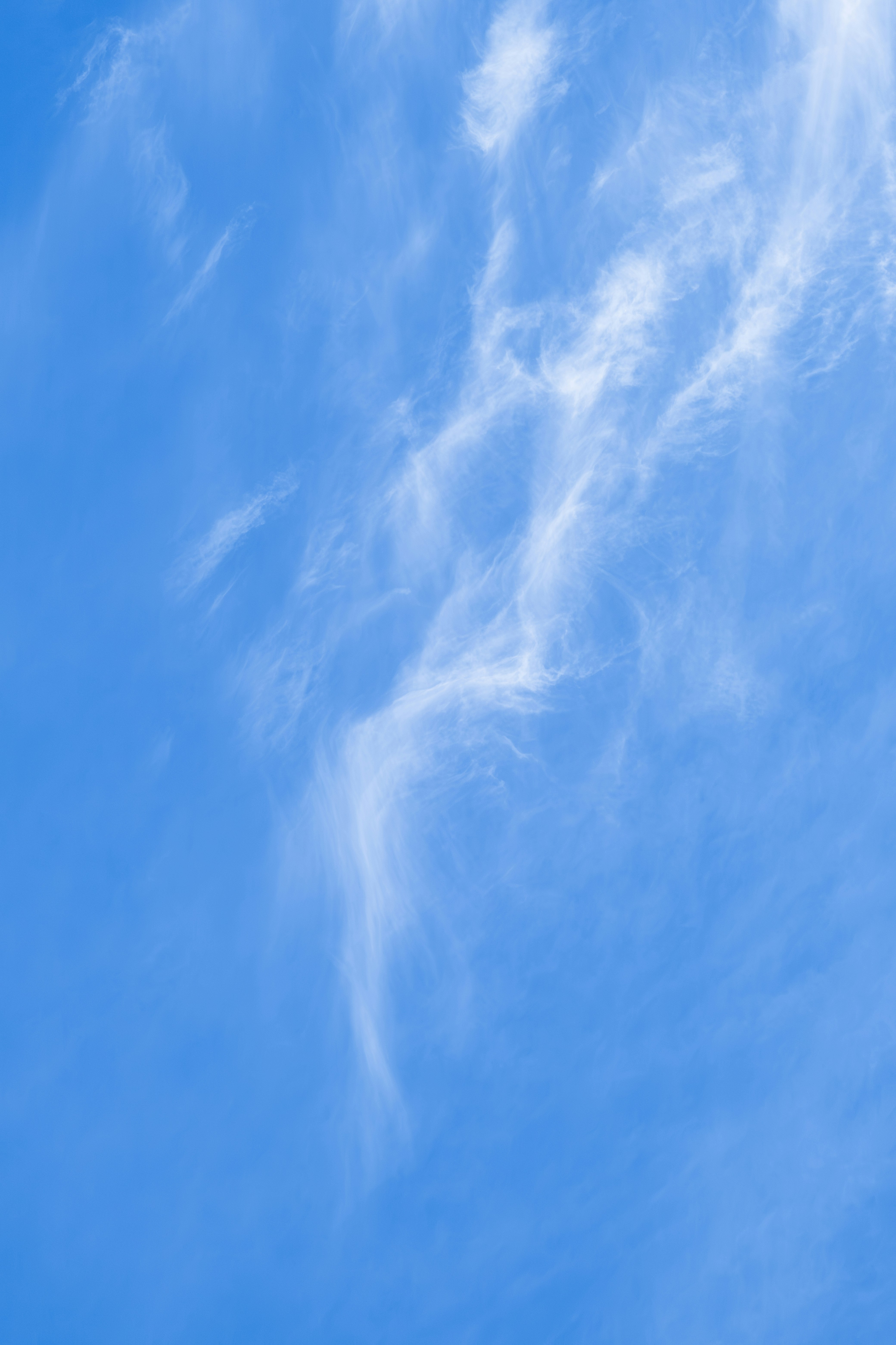 Azure Veil: wisps of cloud drifting across a blue sky