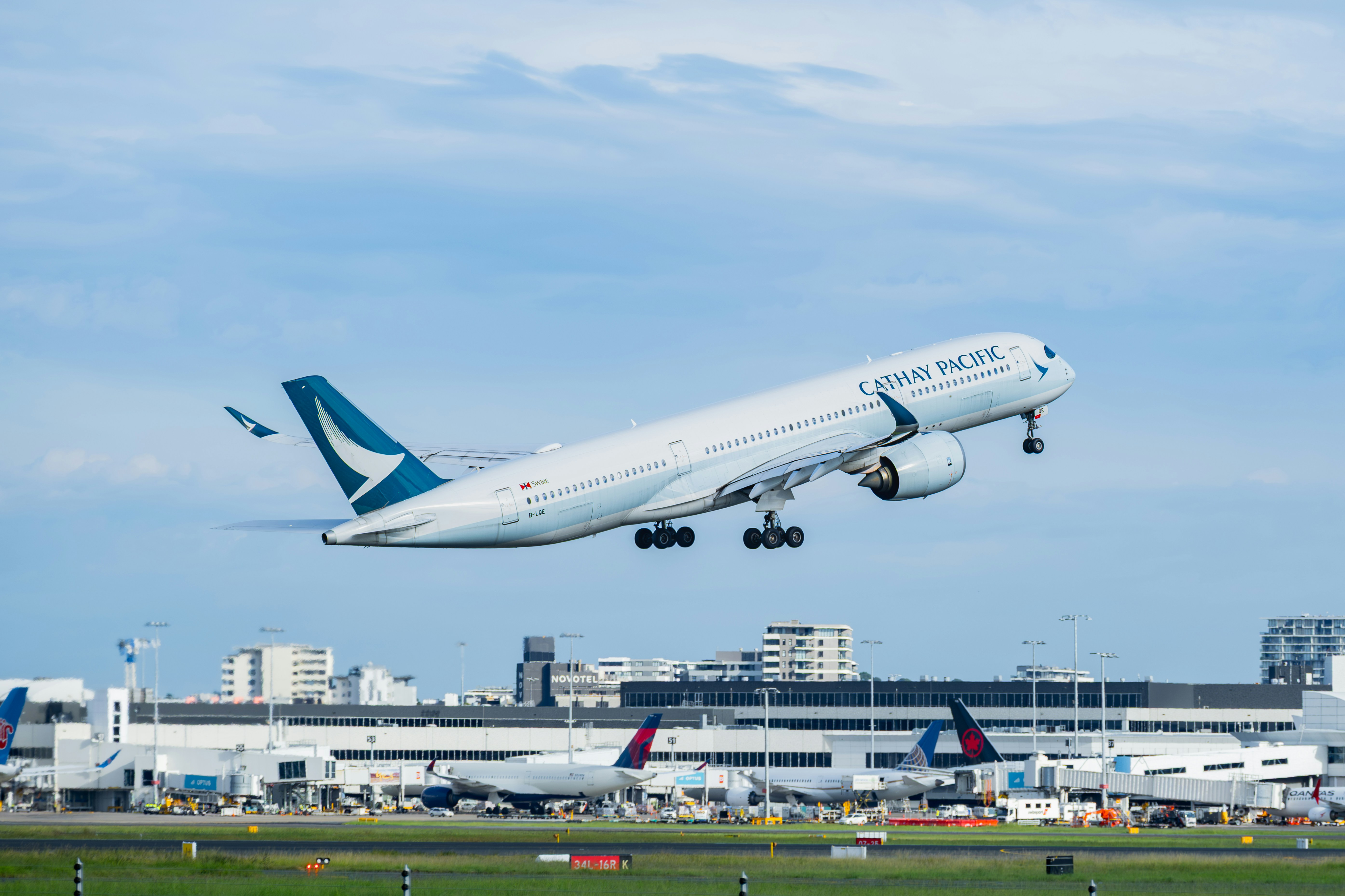 Ascending Cathay: A Cathay Pacific Dreamliner Rises over the Terminal