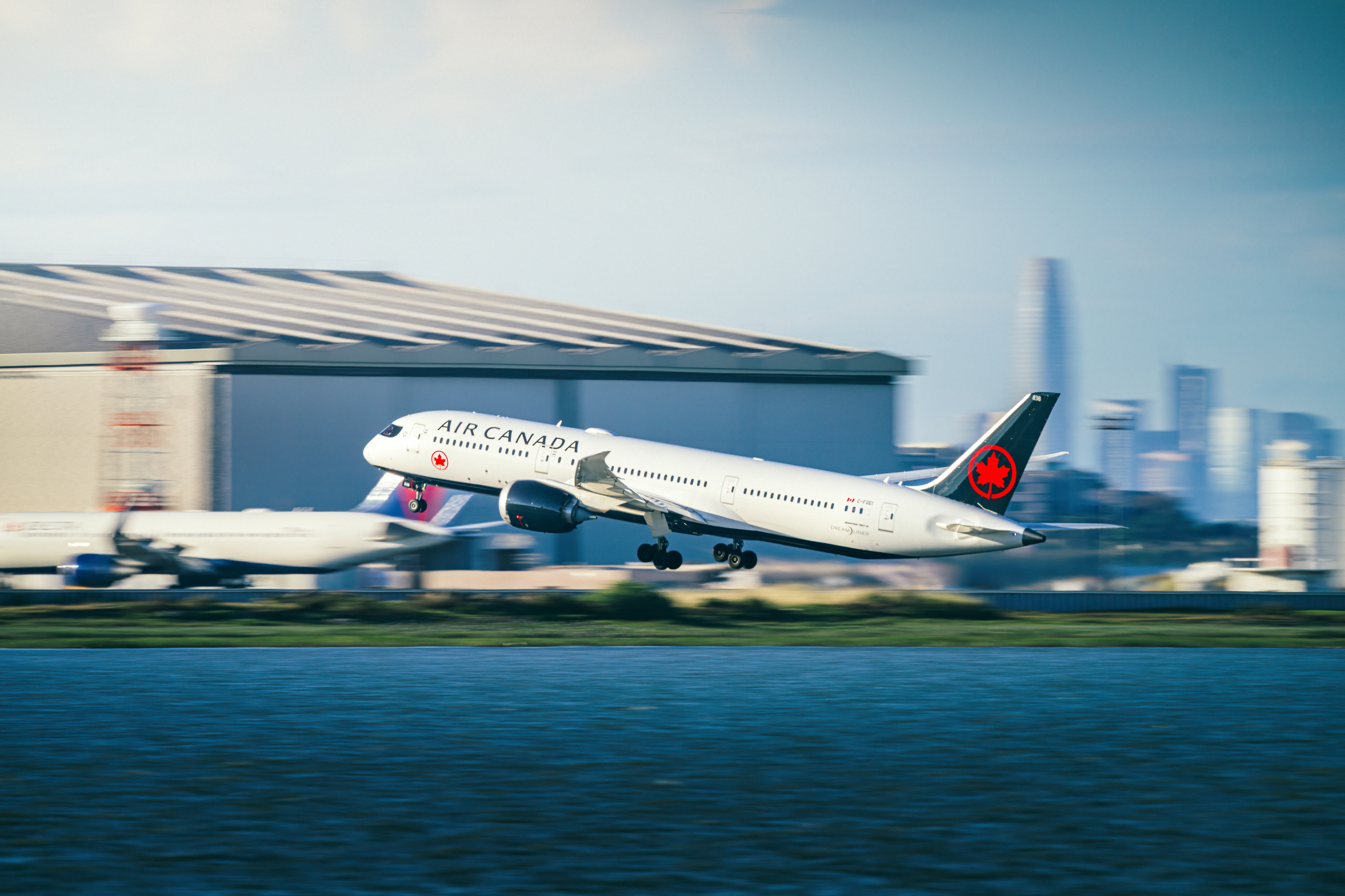 Air Canada Dreamliner on Takeoff Against a City Skyline