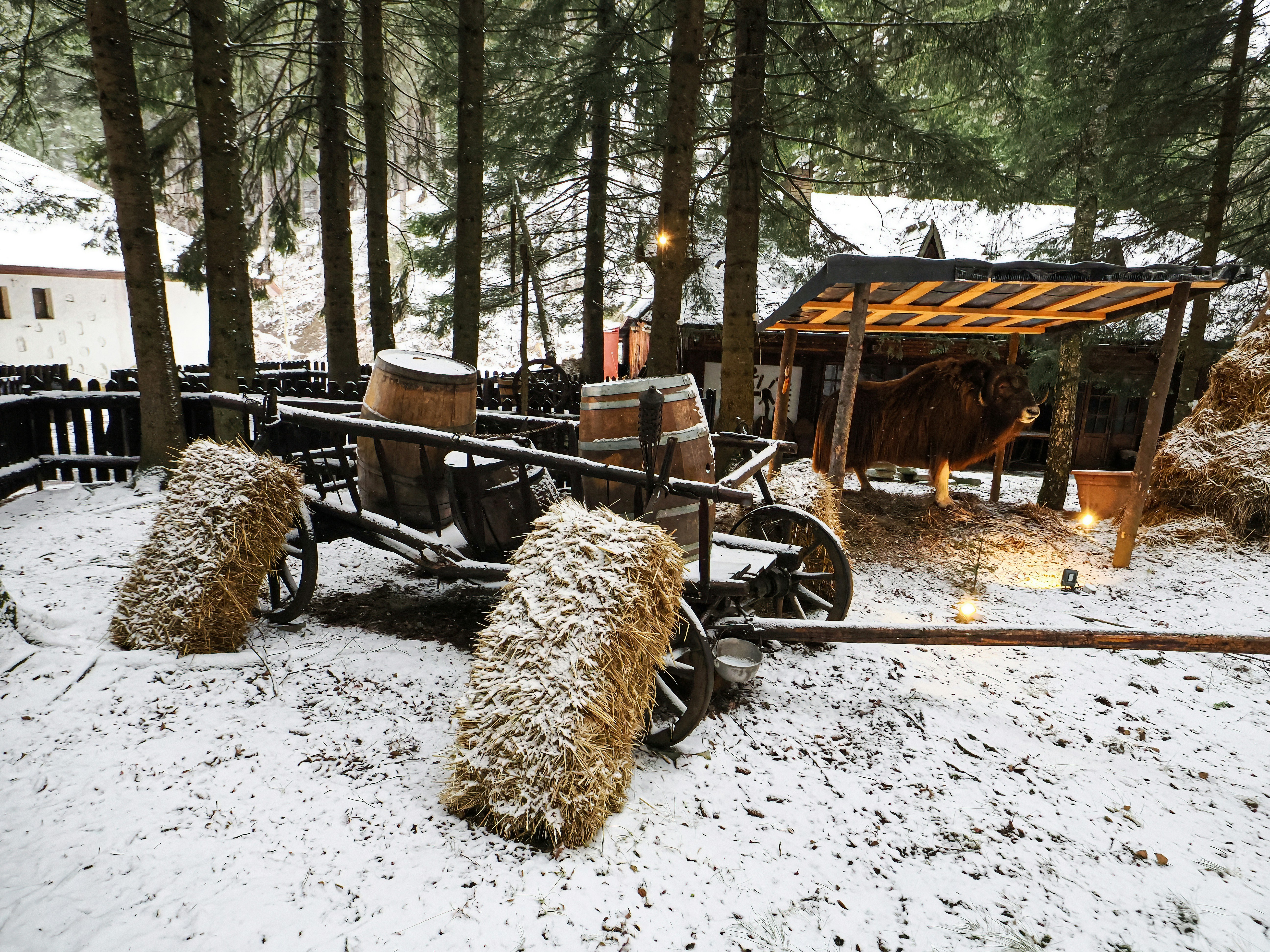 Snowlit Hay Wagon at Dusk: Rustic Farmyard After a Light Fall
