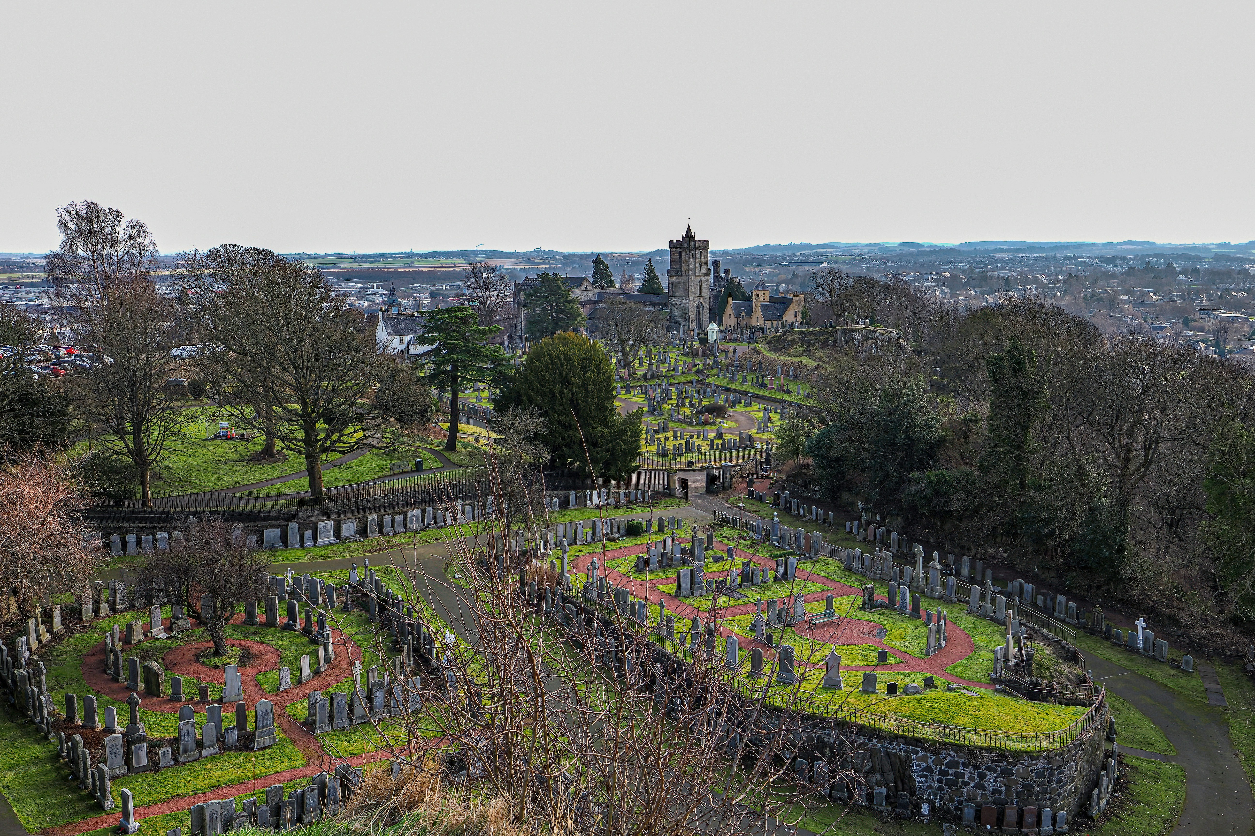 Castle Overlook: Sunlit Walled Gardens and Ancient Headstones