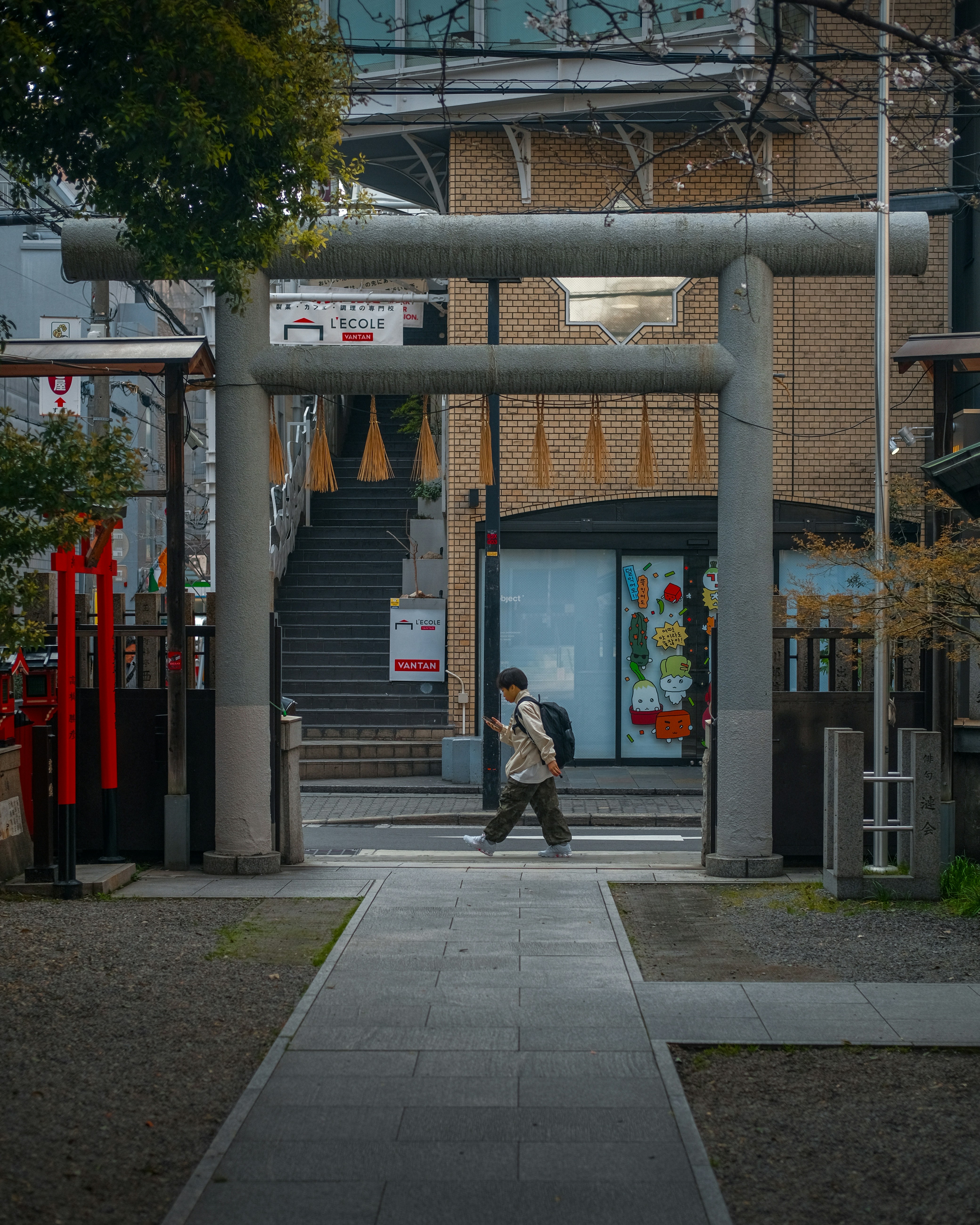 Traveler under the Torii: a lone jogger crosses a quiet urban shrine
