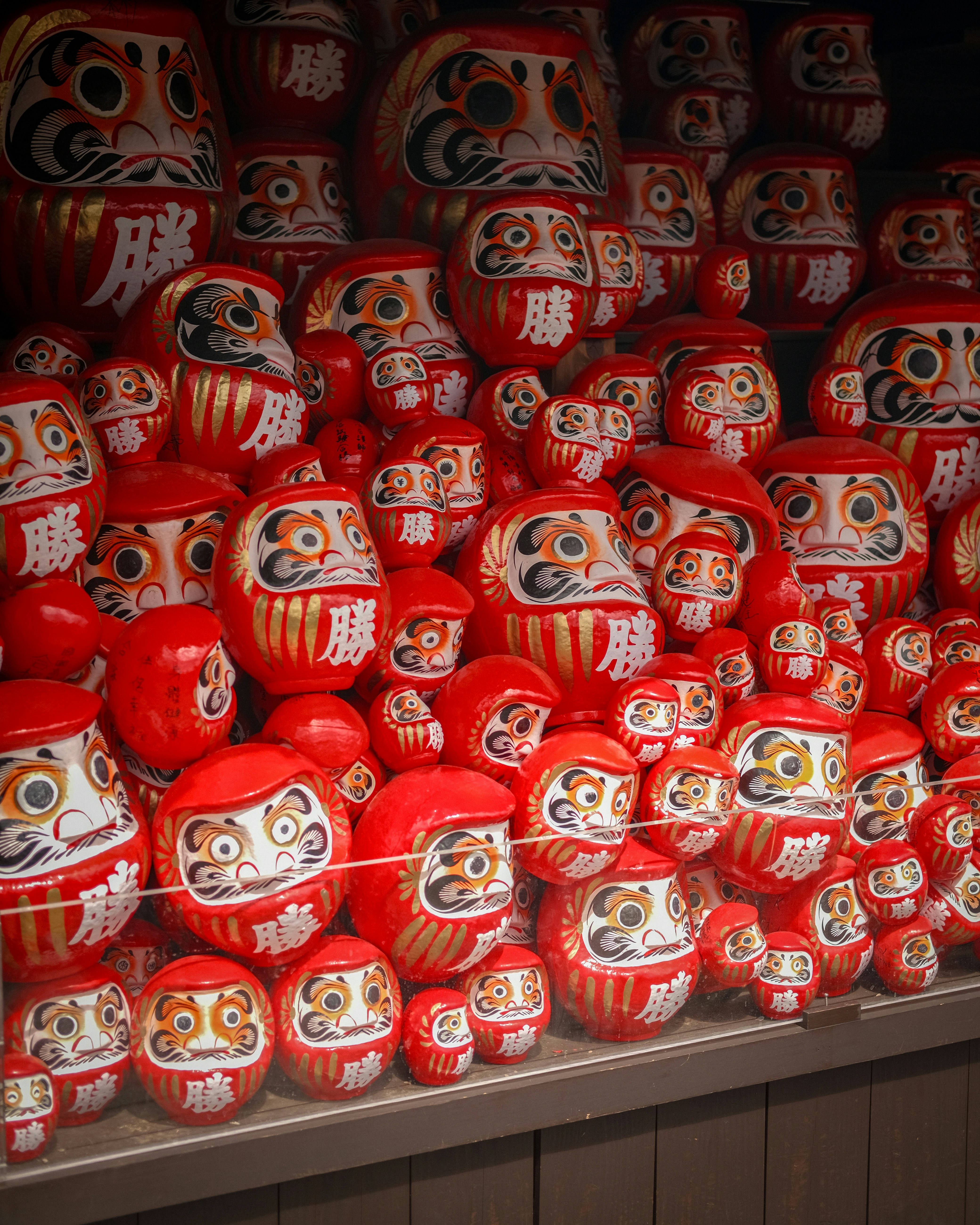 A Sea of Red Daruma Faces: Tradition in a Dense Display