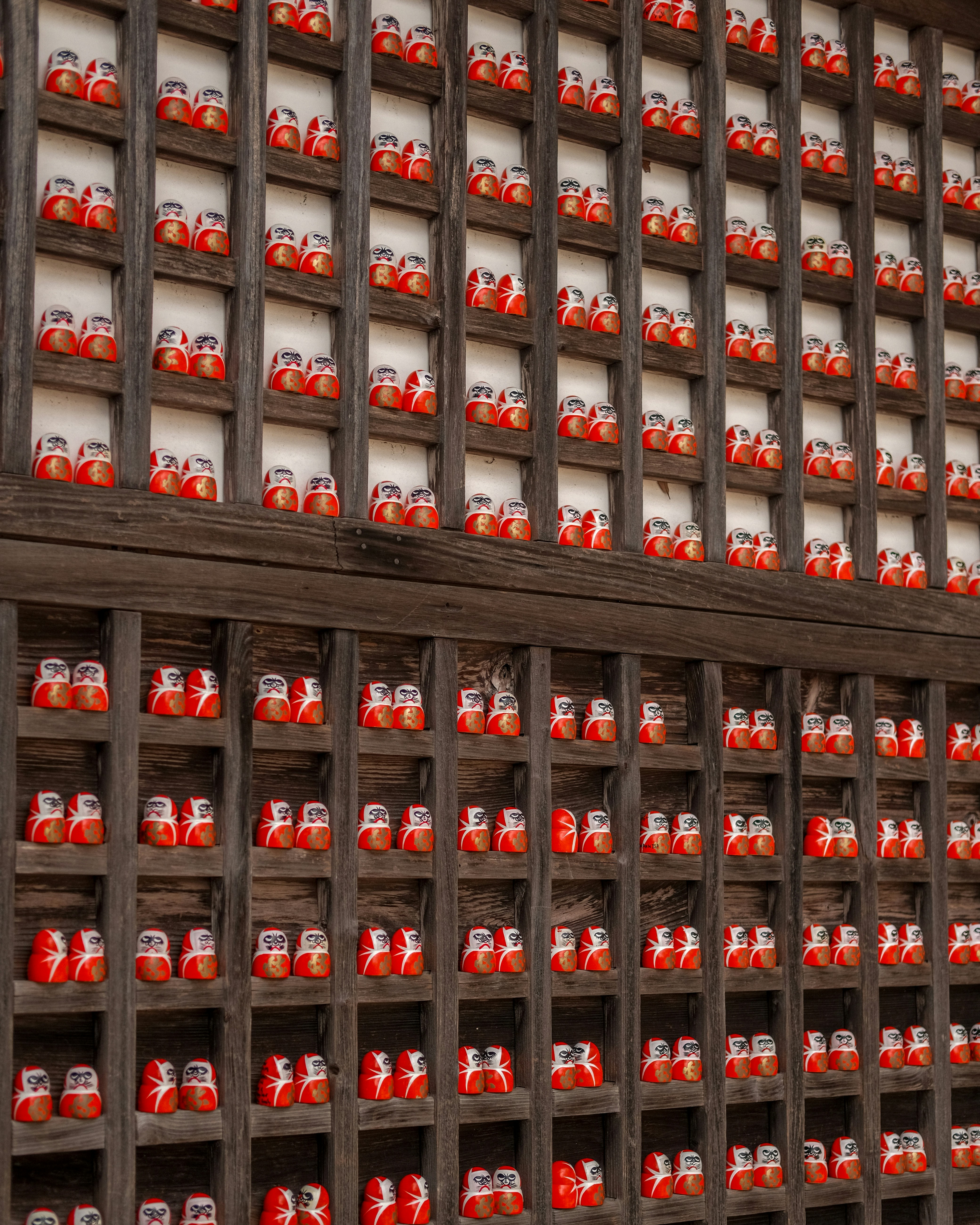 Grid of Red-and-White Cushions in a Timber Lattice