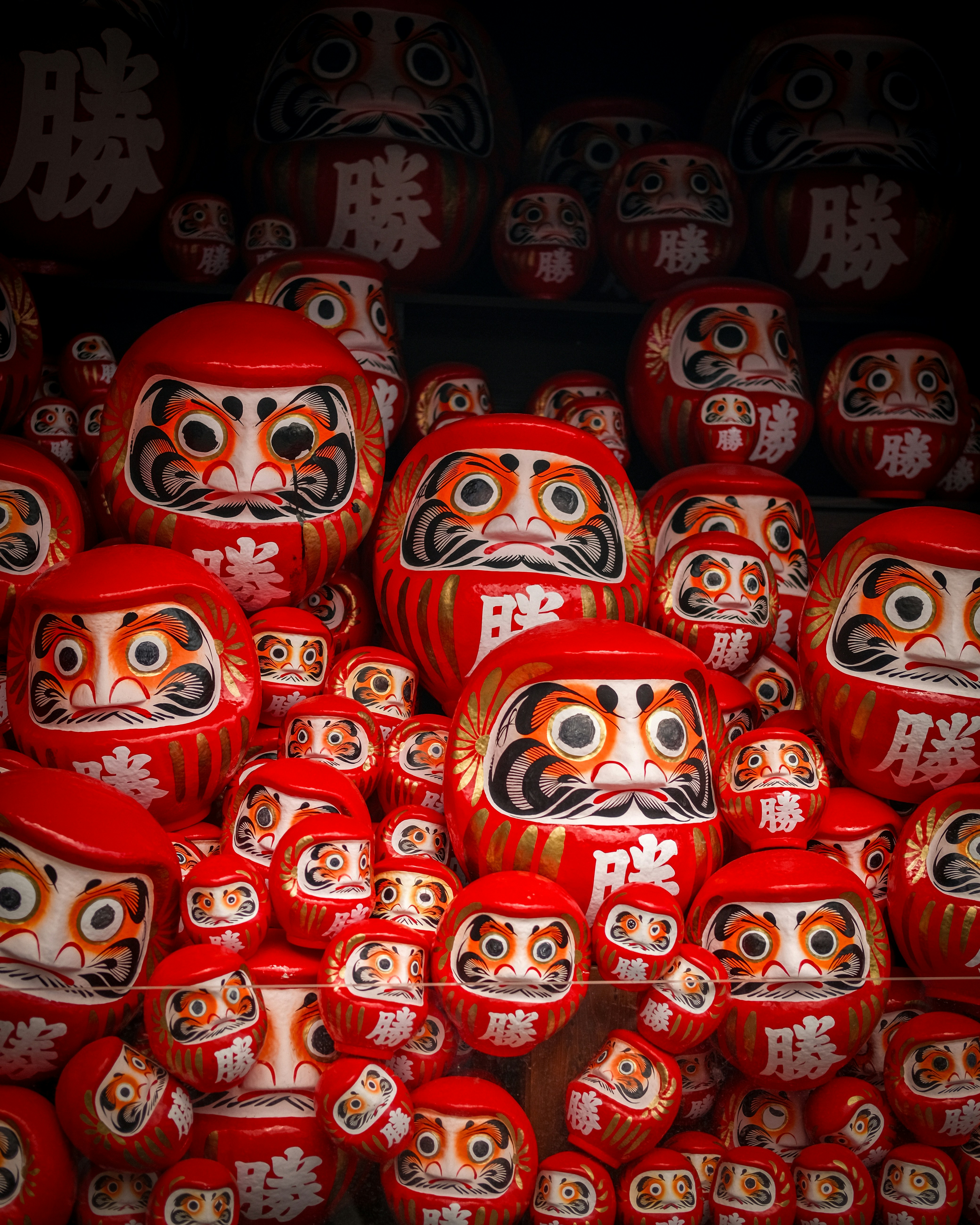 Red Crowned Faces: A Sea of Daruma Doll Reverie