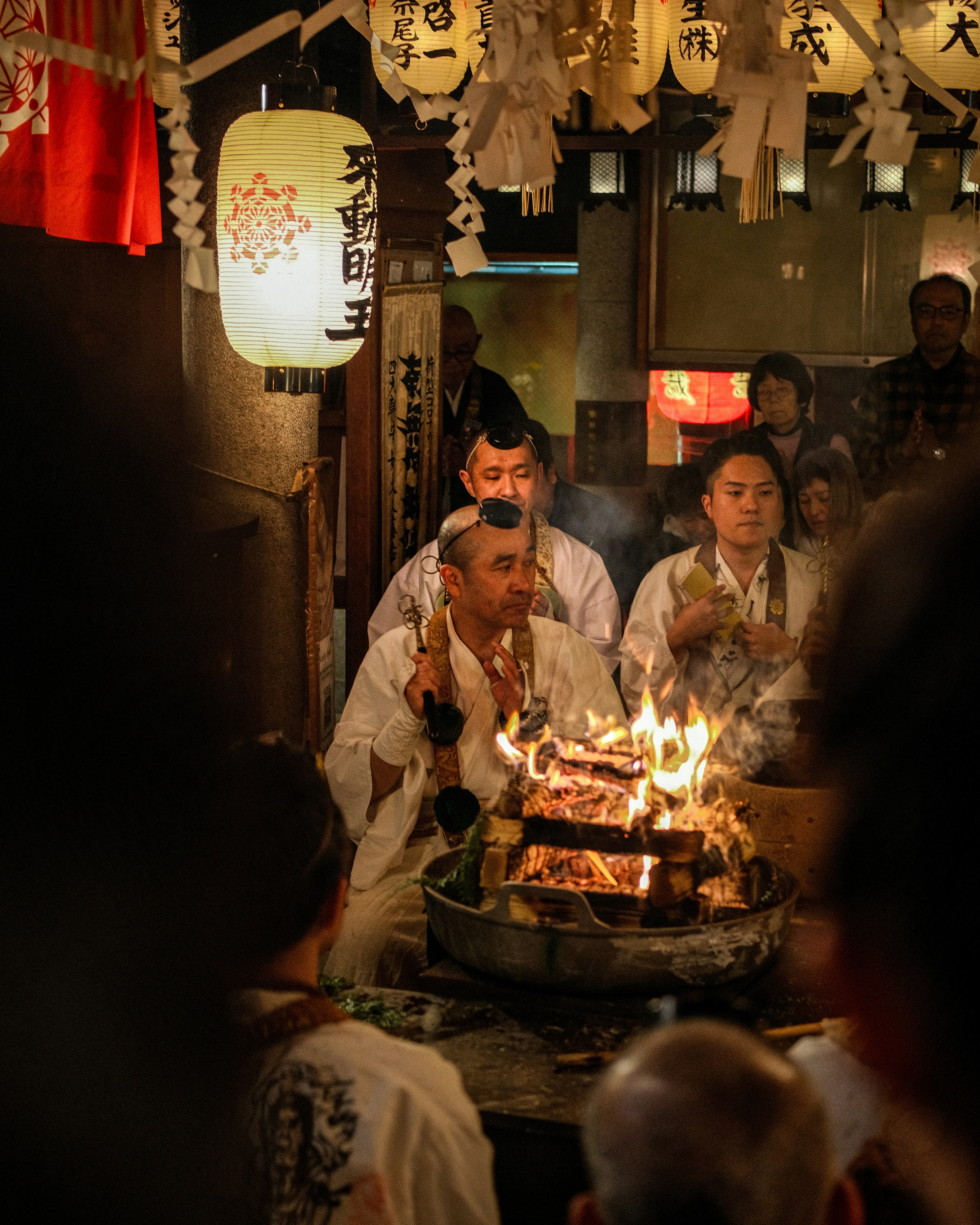 Ritual Flame: Clerics and Onlookers Gathered Around a Sacred Fire