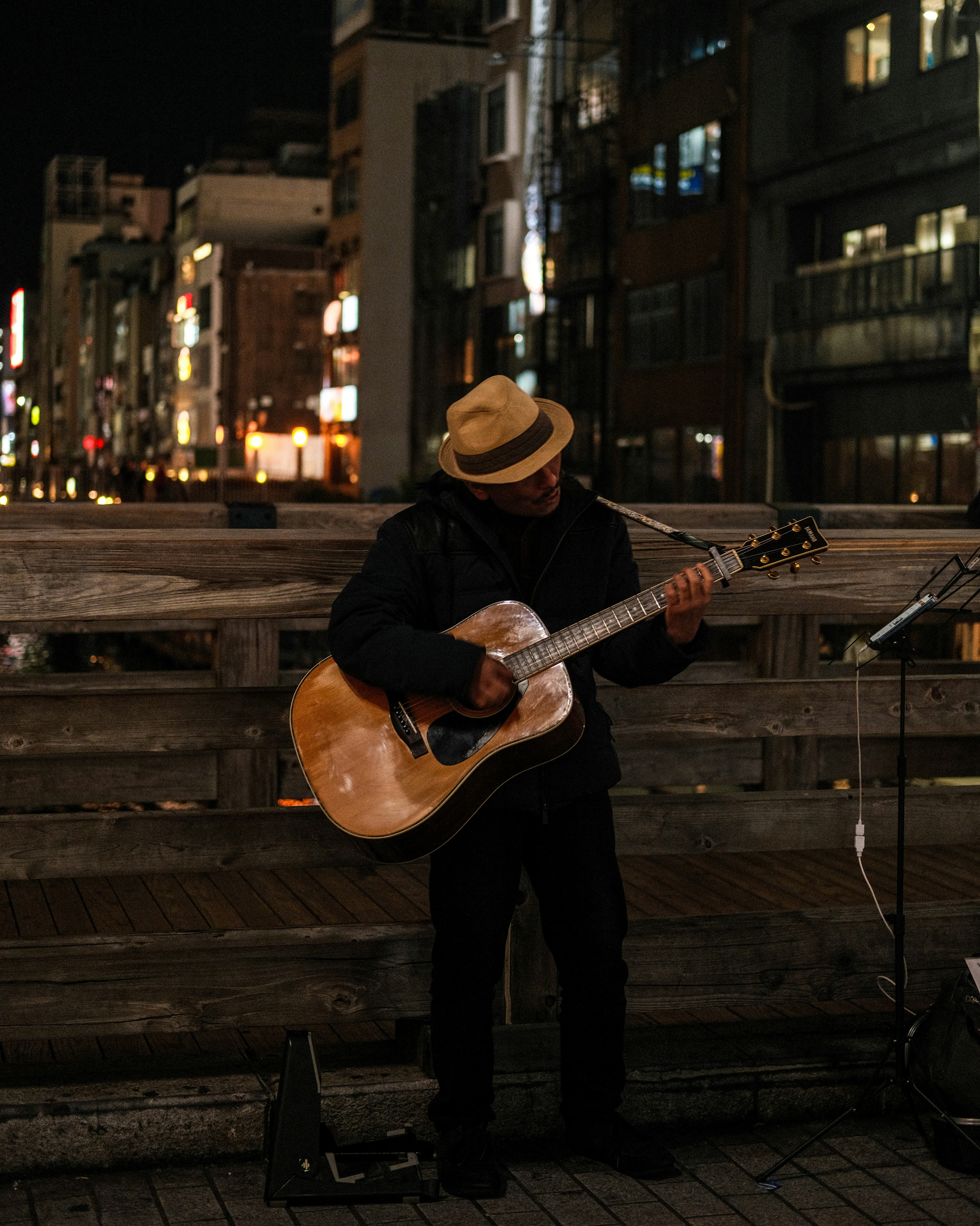 Night Street Serenade: A Guitarist Under City Lights