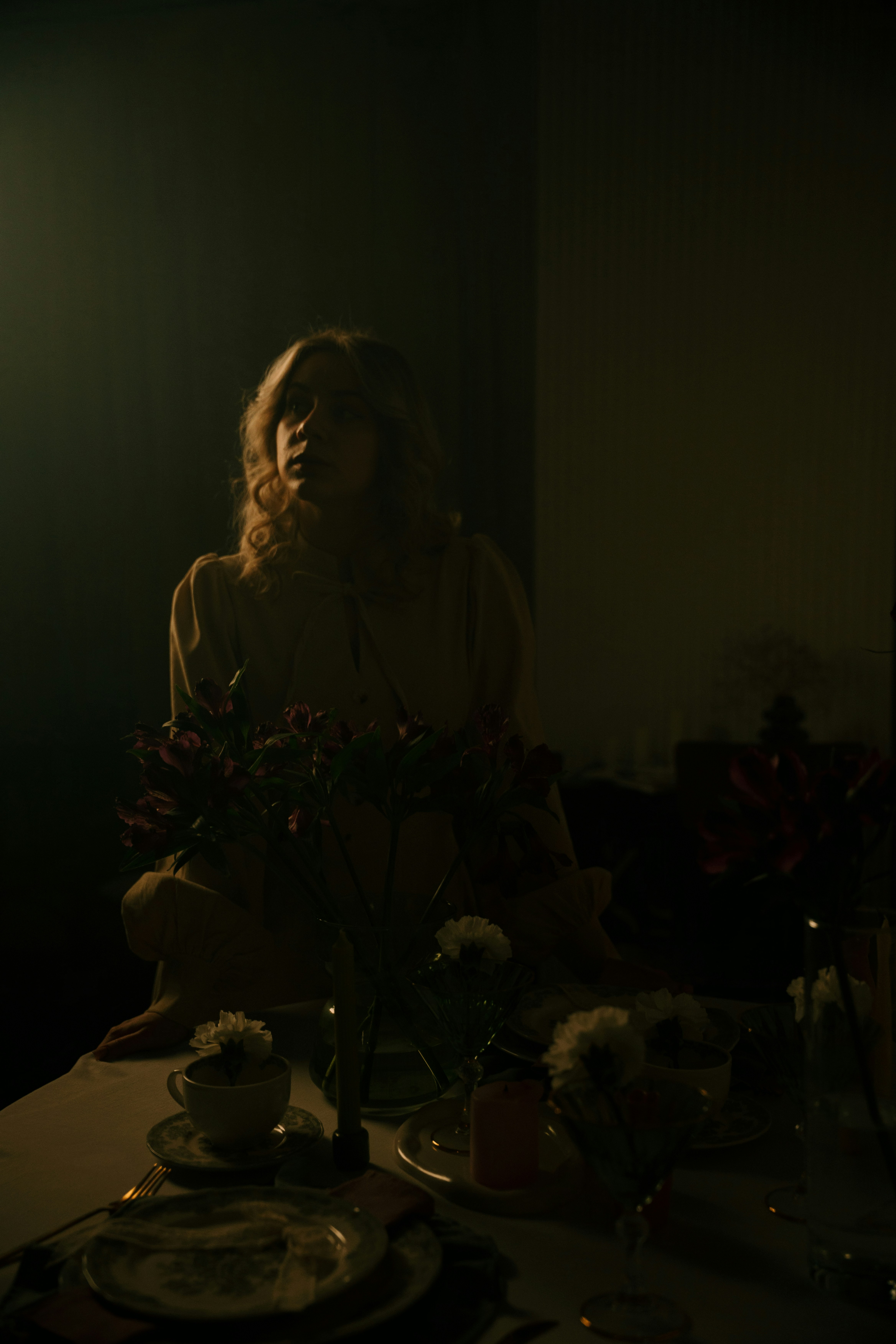 Softly Lit Portrait Beneath a Tabletop Arrangement