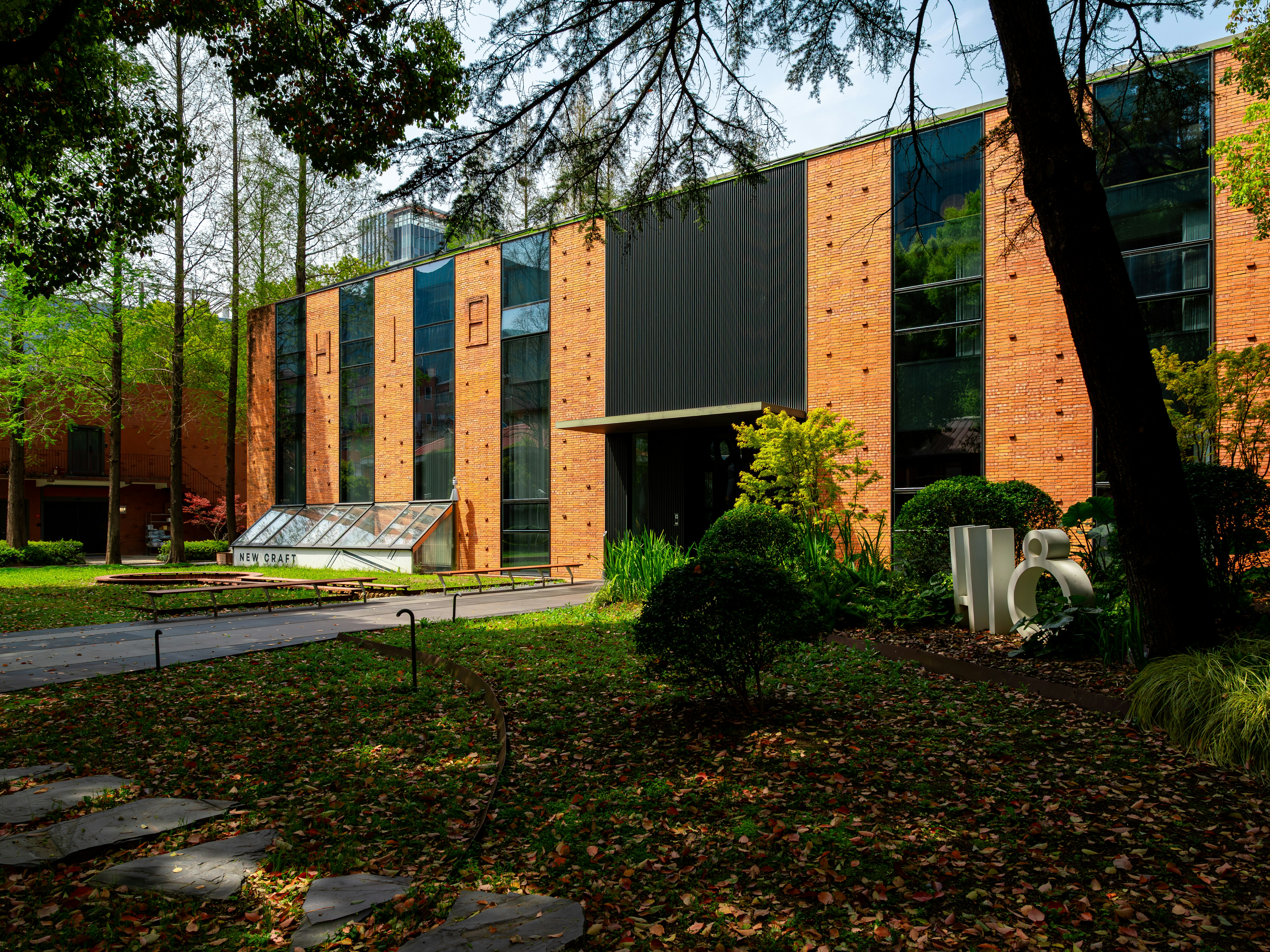 Brick-and-Glass Campus Facade Framed by Trees