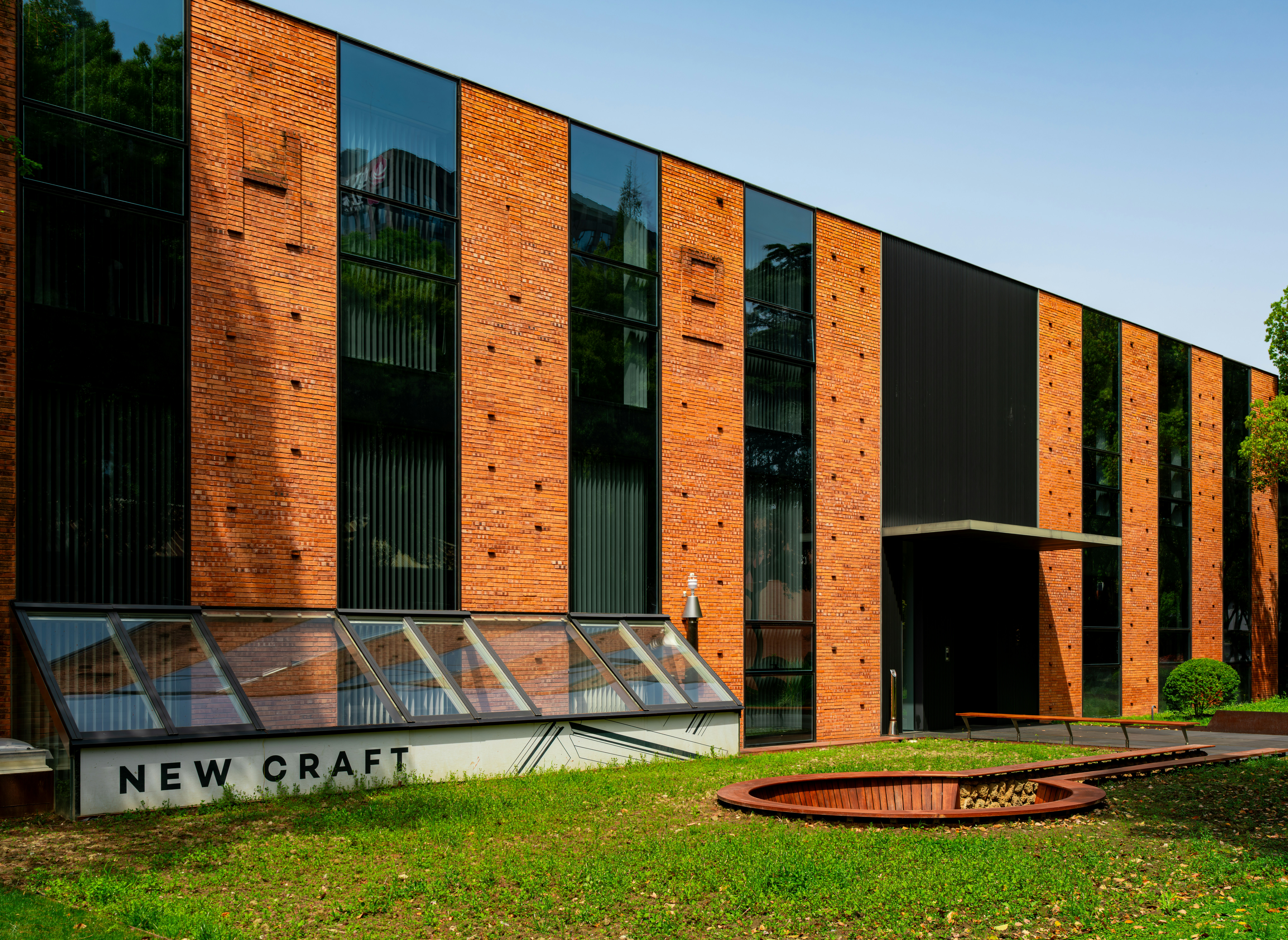 Brick Facade, Glass Canopy, and Circular Lawn Sculpture