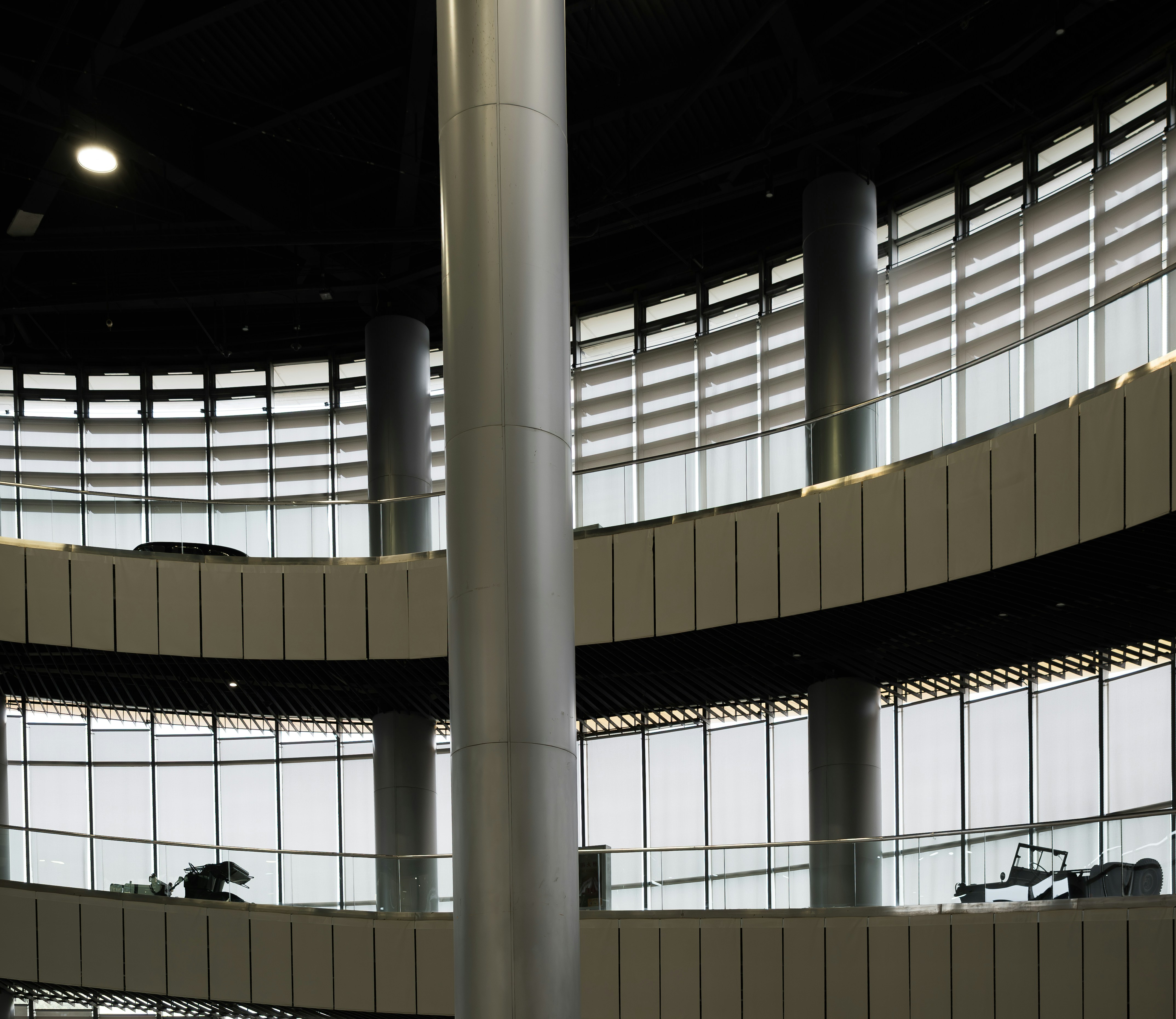 Curved Atrium Graces the Vertical Steel Columns