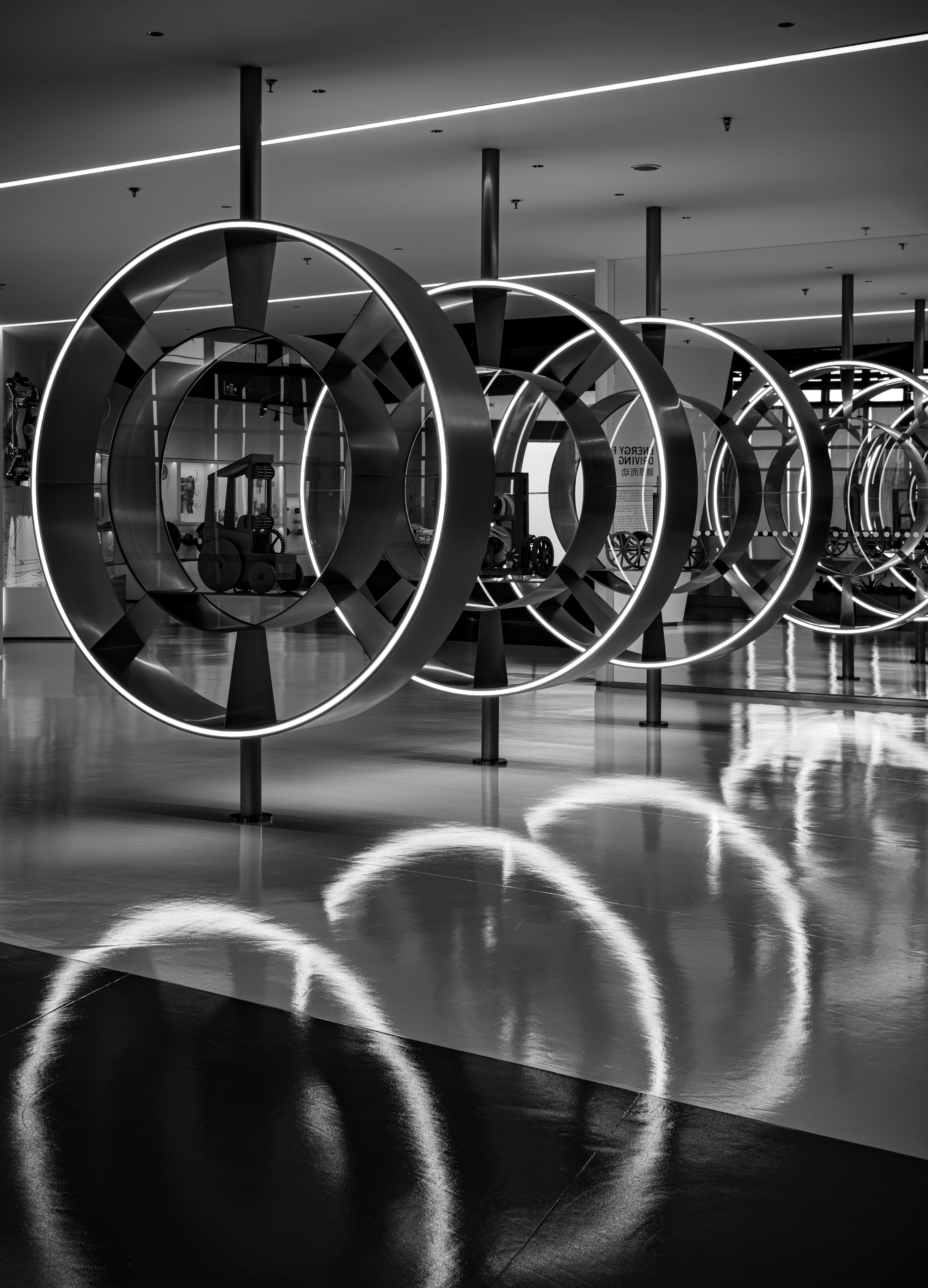 Circular sculpted rings in a monochrome showroom