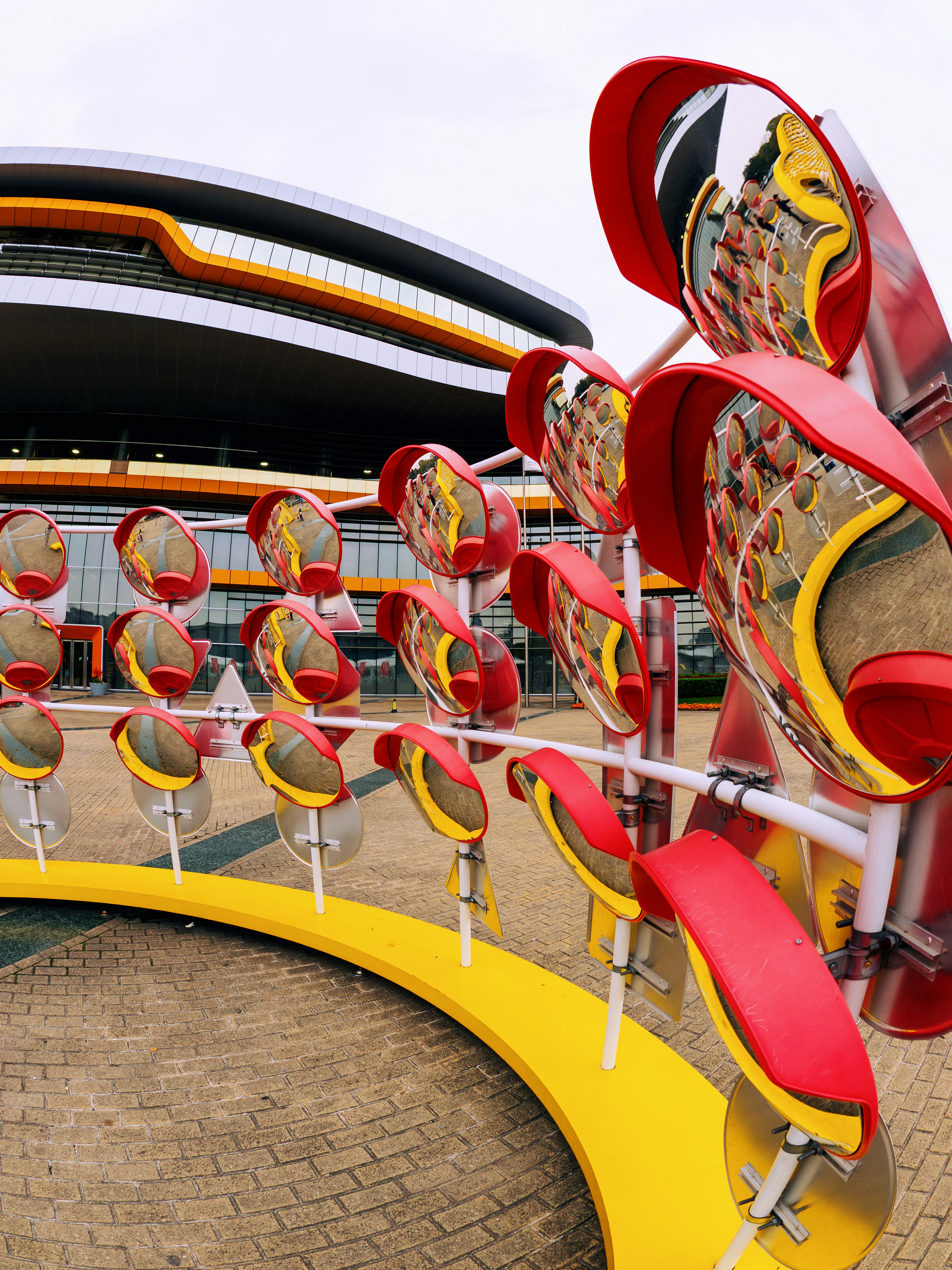Reflective Red Orbs: A Playground of Curved Mirrors by the Entrance