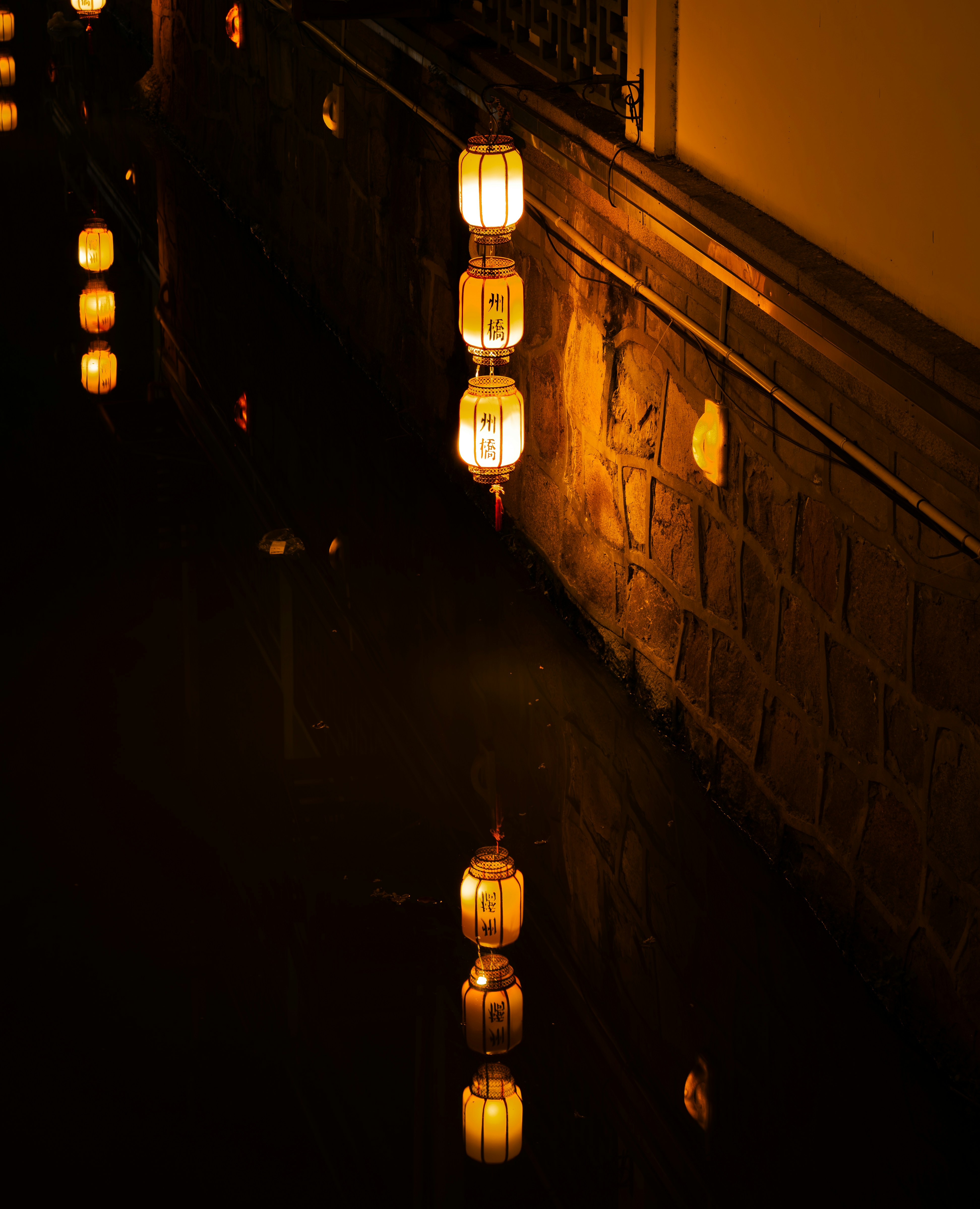 Floating Lanterns Over a Narrow Night Canal