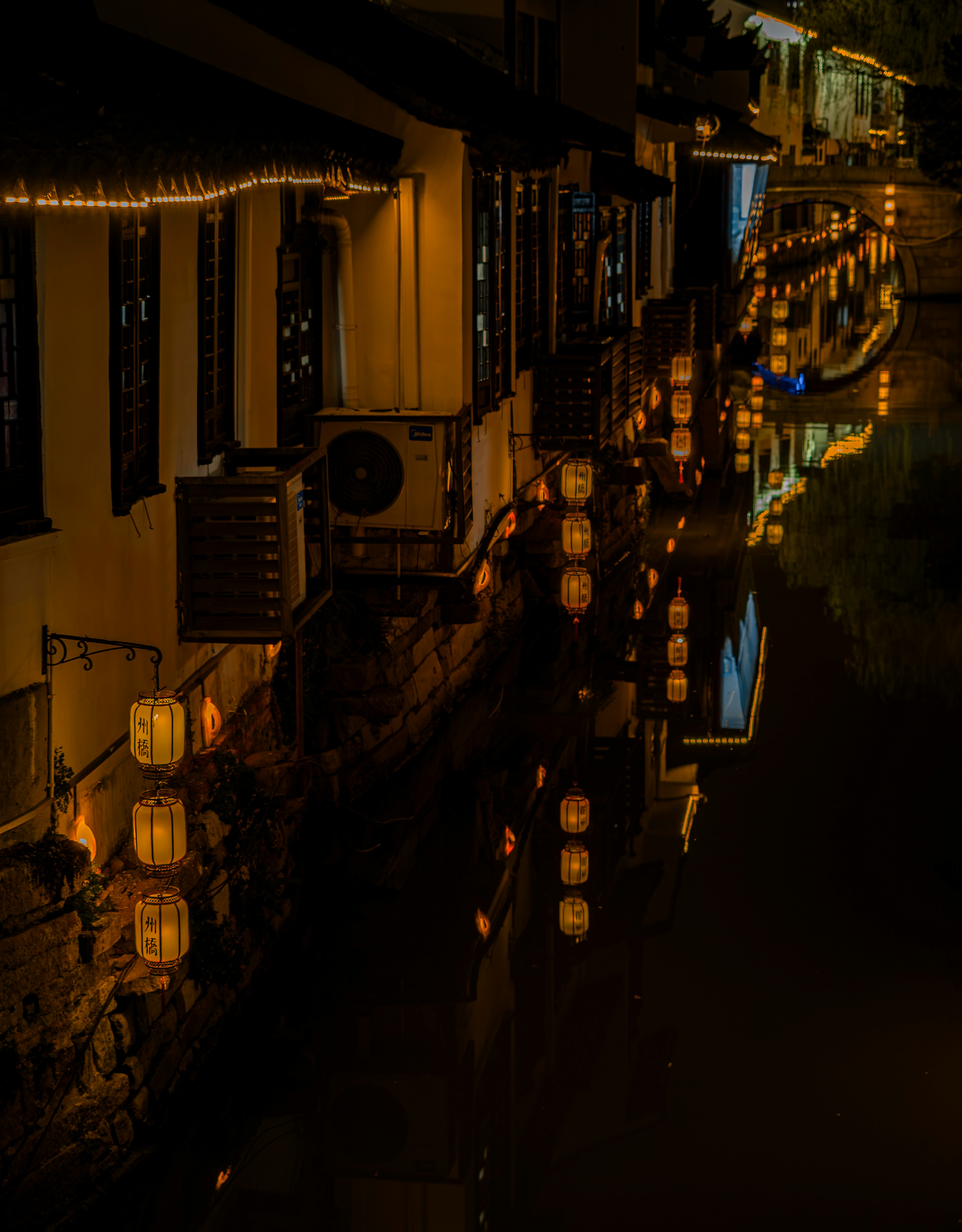 Lantern-lit canal corridor: a glowing night in an ancient street