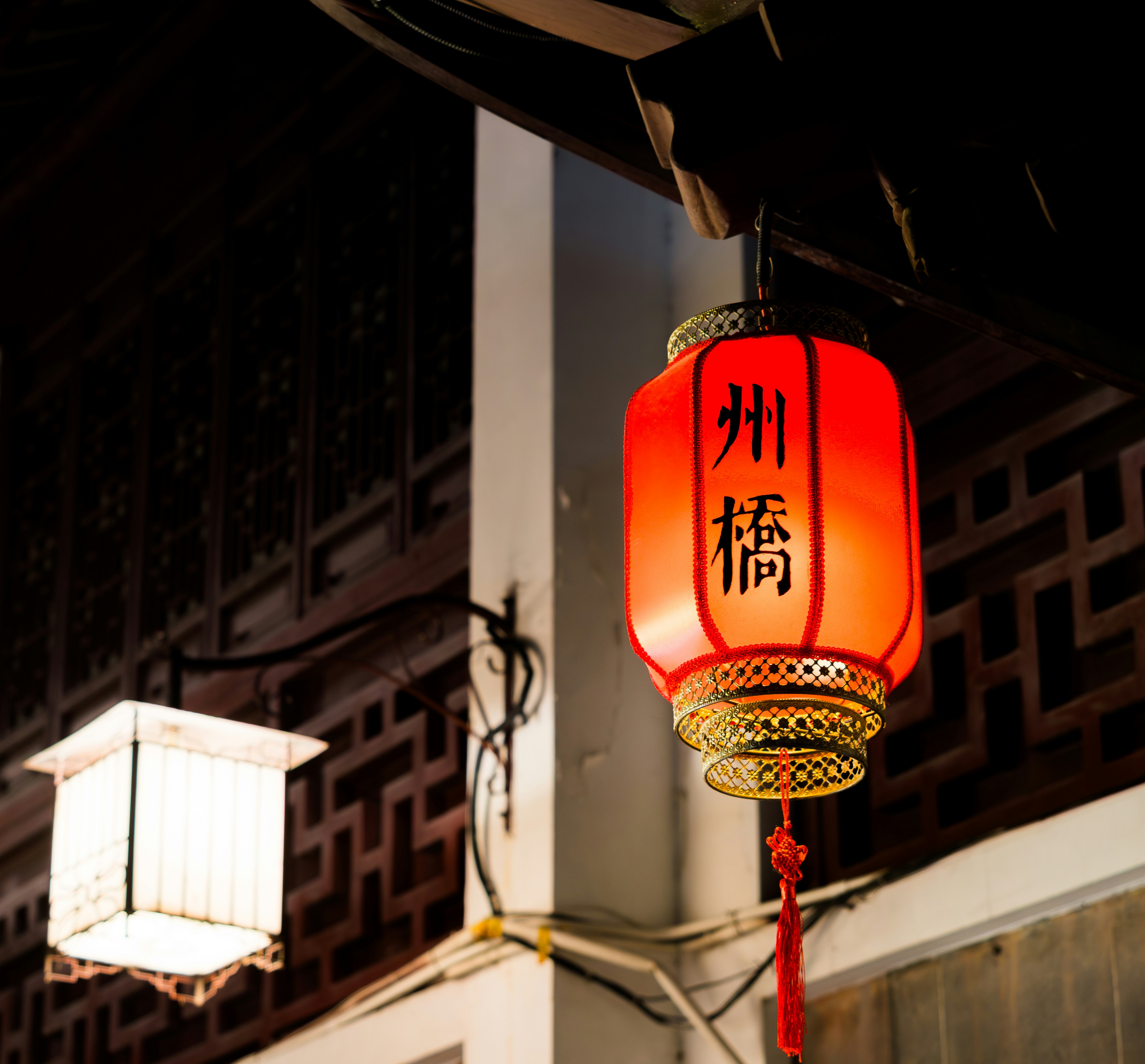 Red Lantern Glow Against Lattice Shadows