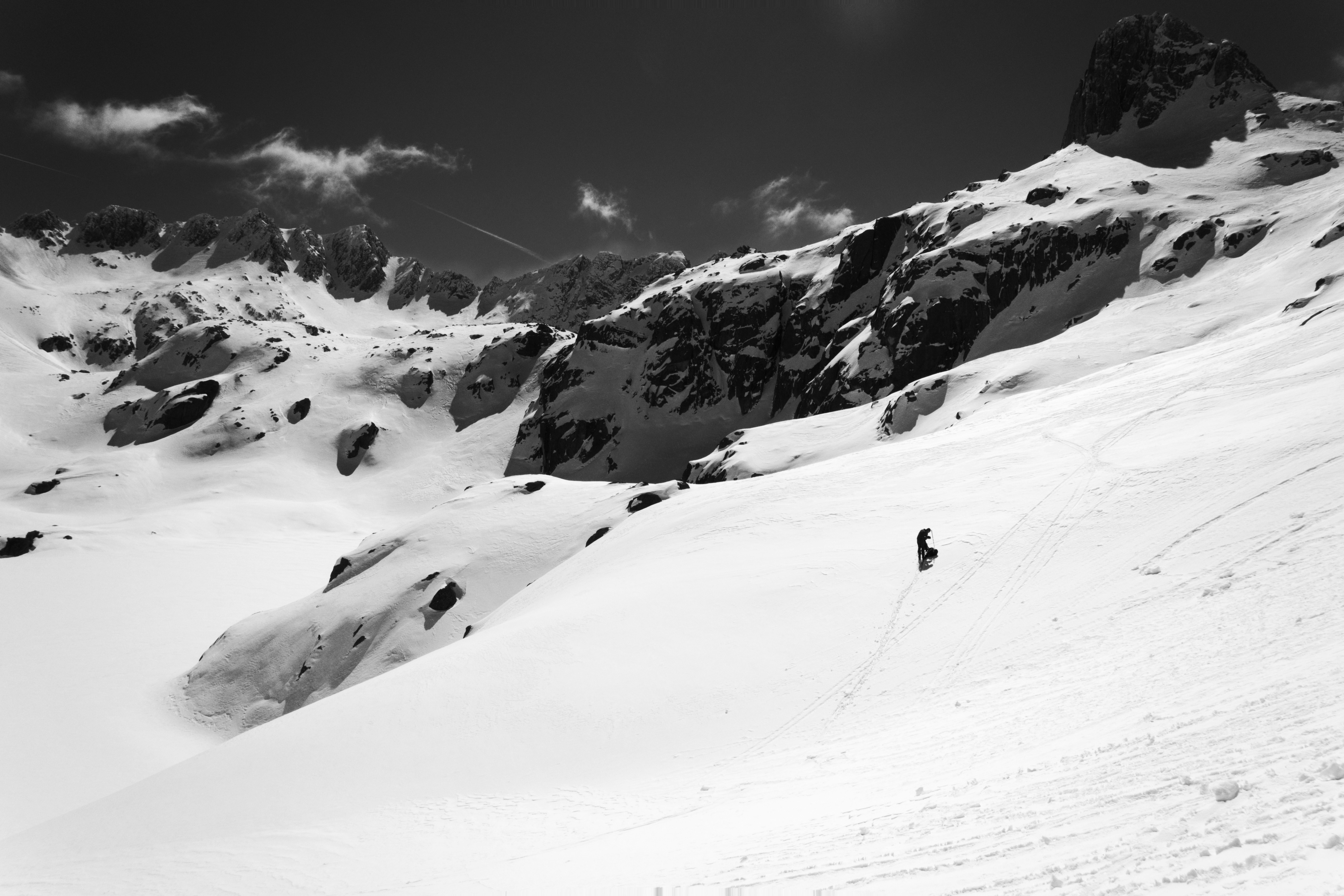 Snowbound Ascent: A Lone Skier Traces a Silent Ridge