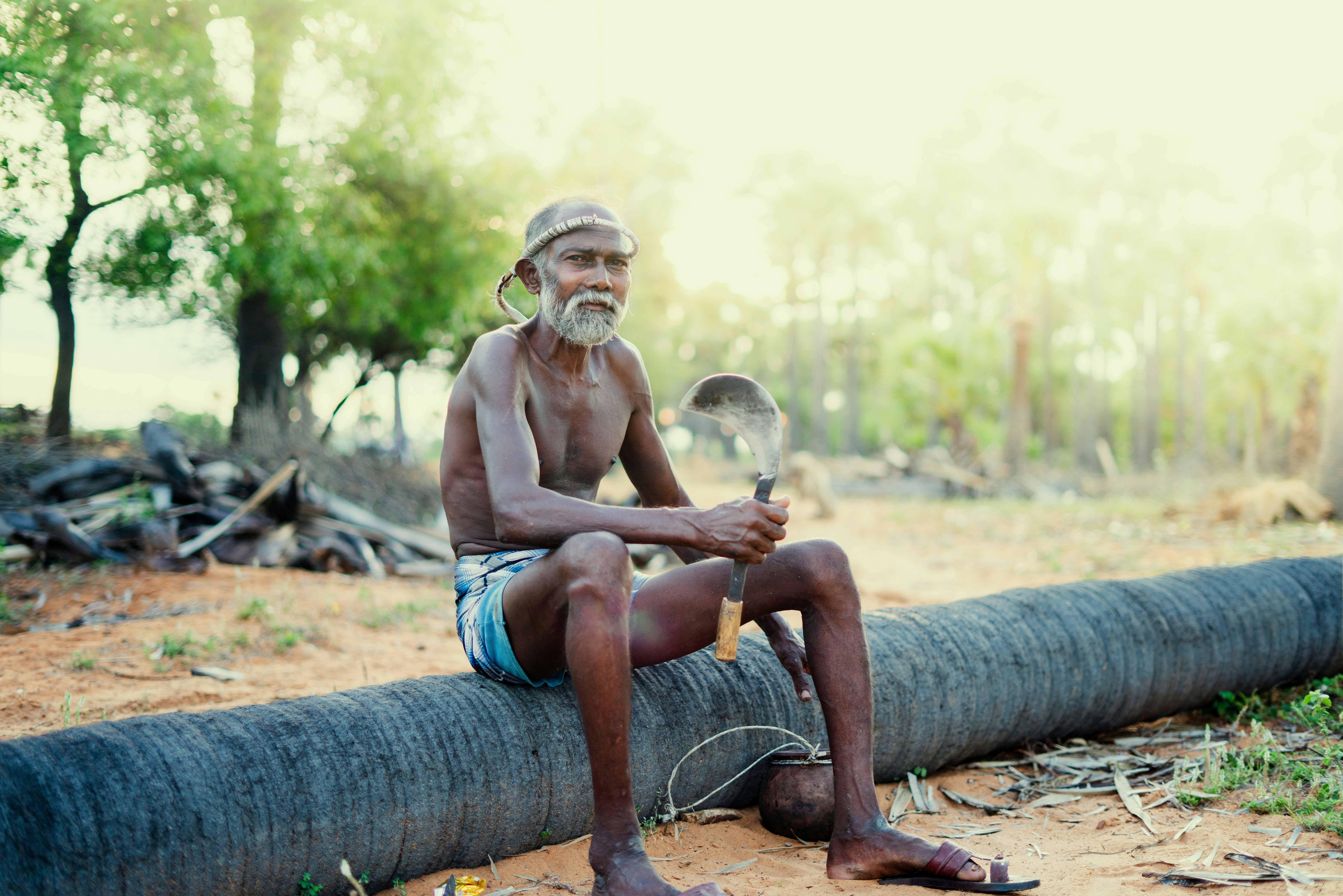 Old Woodsman with Axe by a Pipelineside Log