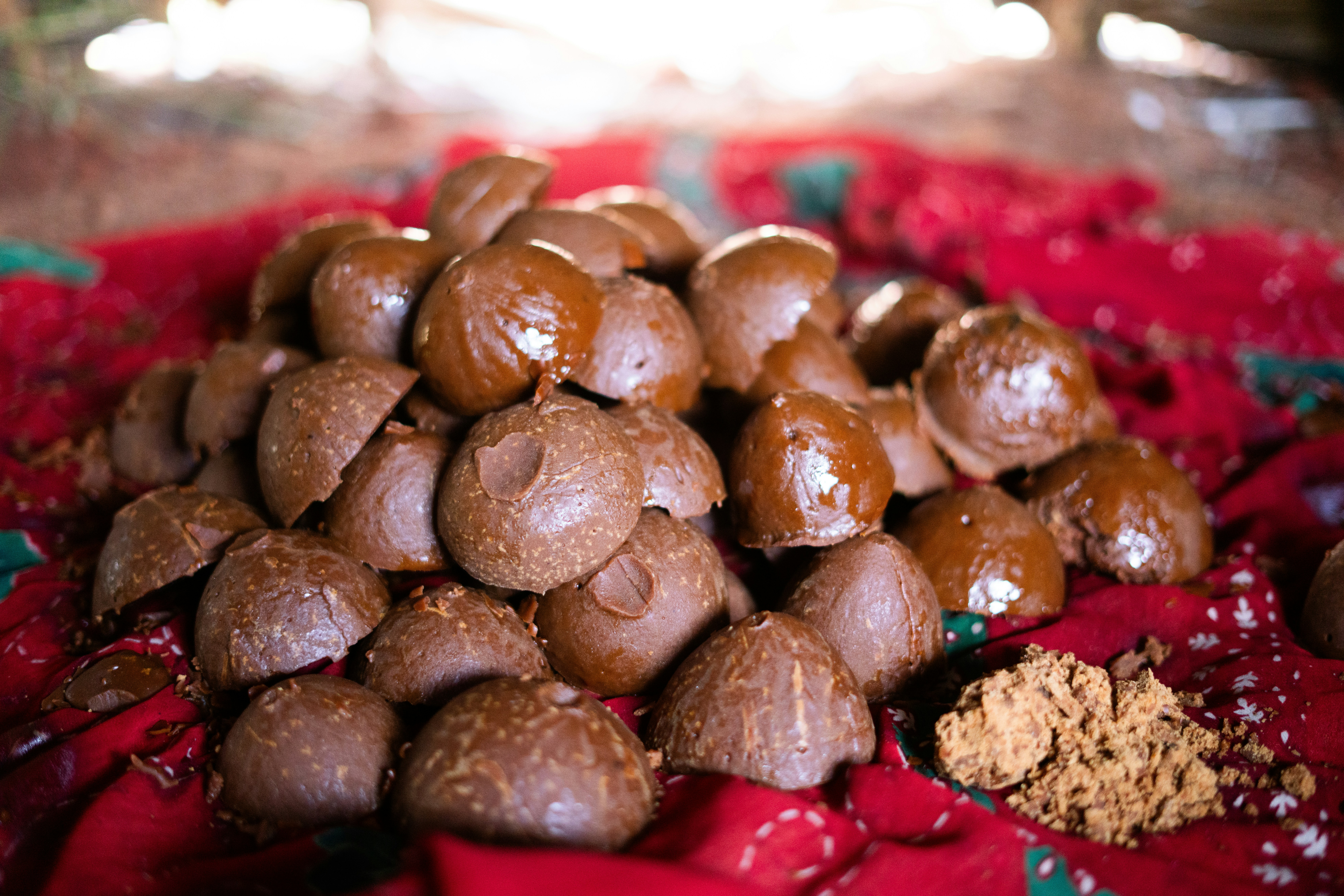 Glossy Cocoa Nibbles on a Red Textile Treasure