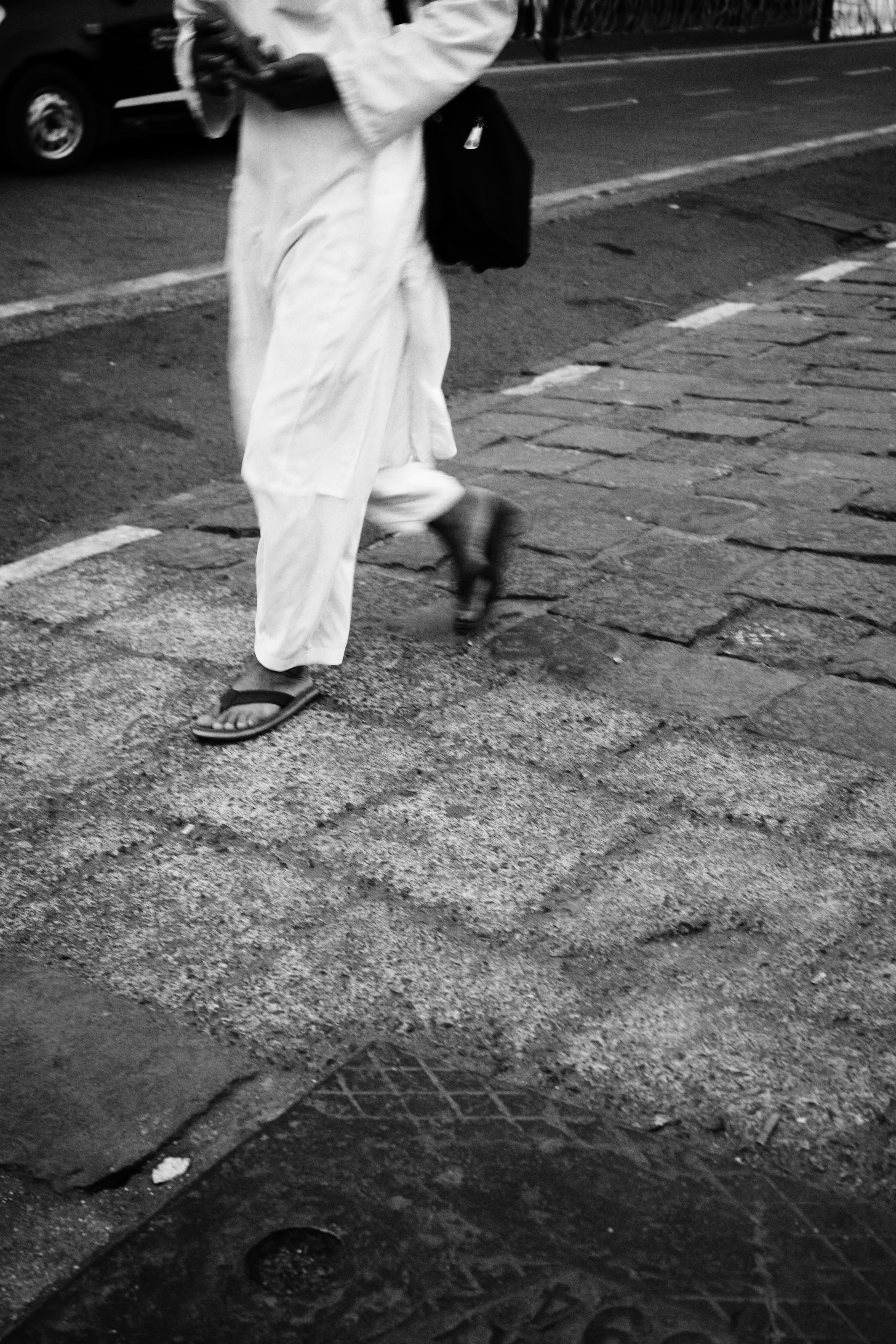 Motion in Slippered Step: A Partially-Framed Pedestrian Crossing the Cobblestones