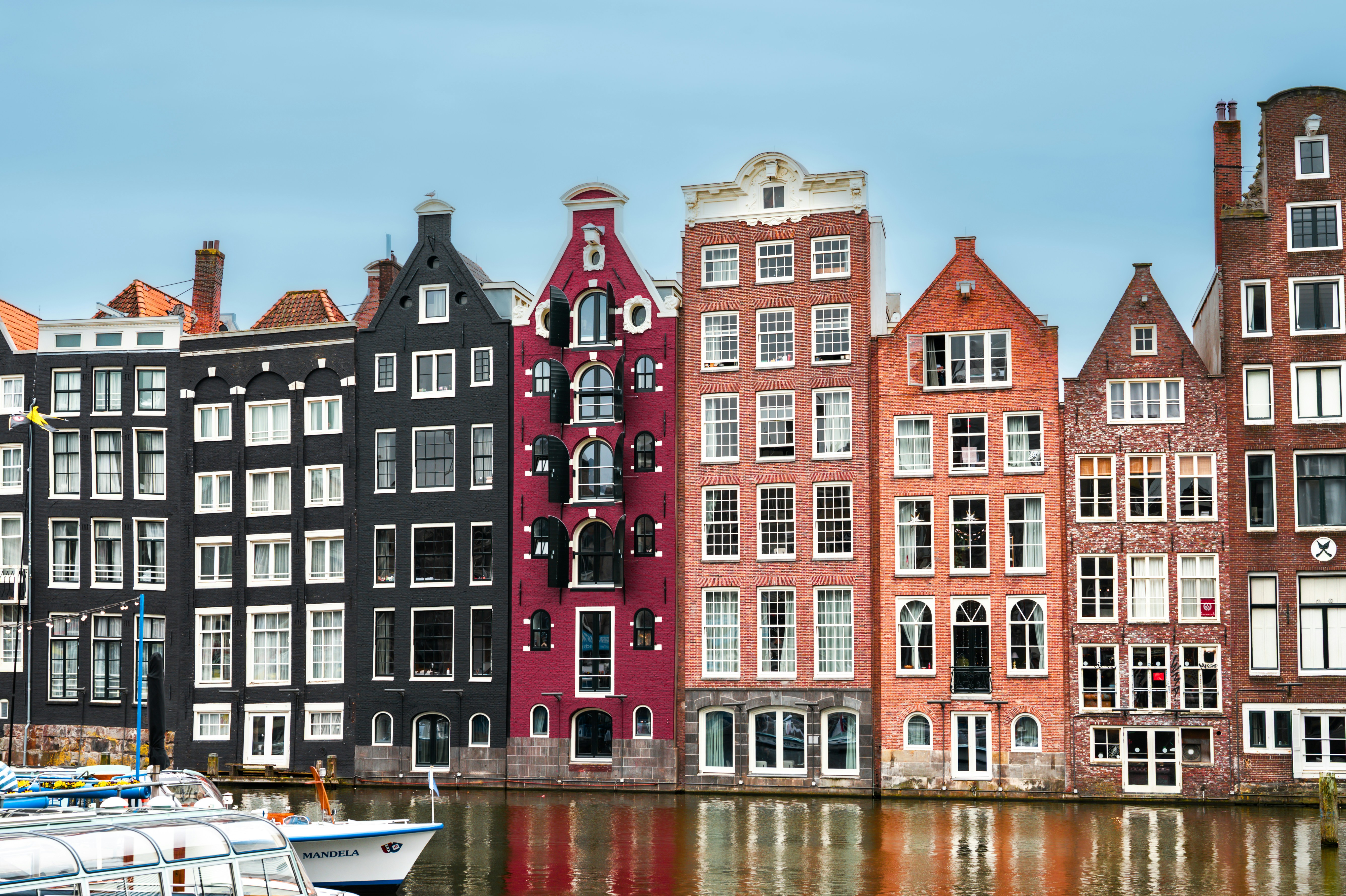 Colorful canal houses lining a calm waterway