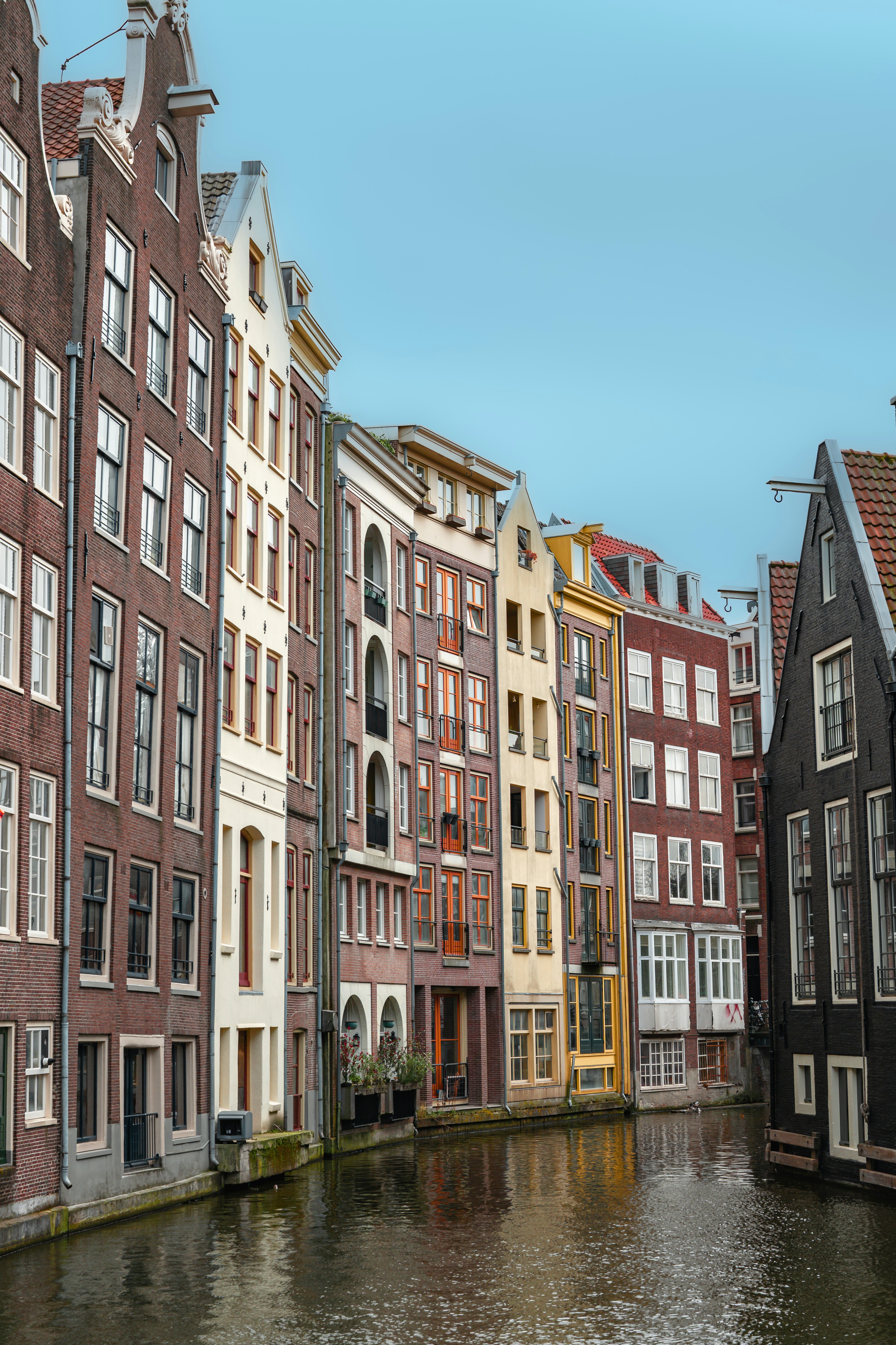 Canalfront Facades: A Colorful Row of Dutch Gables Reflecting in Still Water