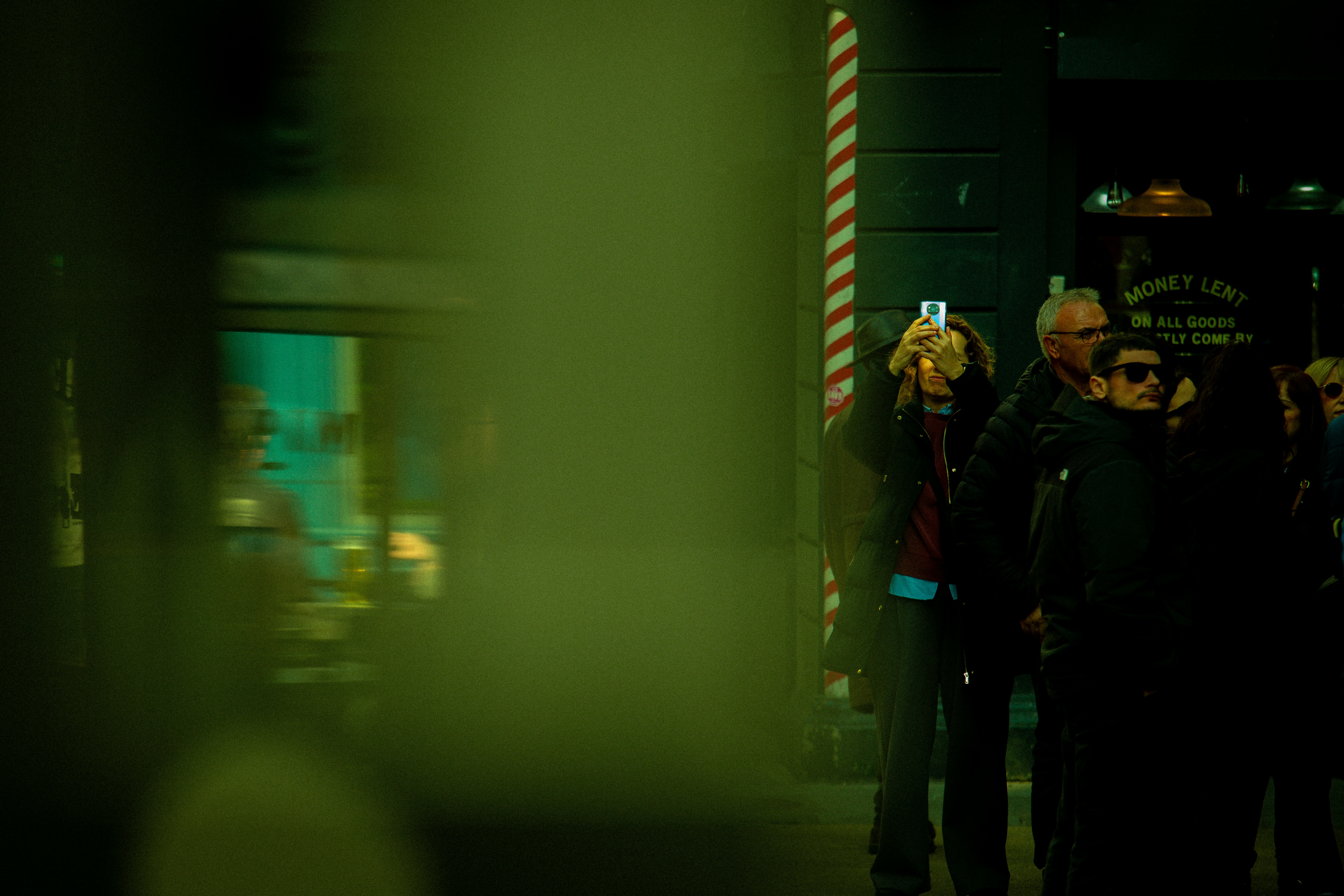 City Street Portrait: A Quiet Moment Behind the Curtain