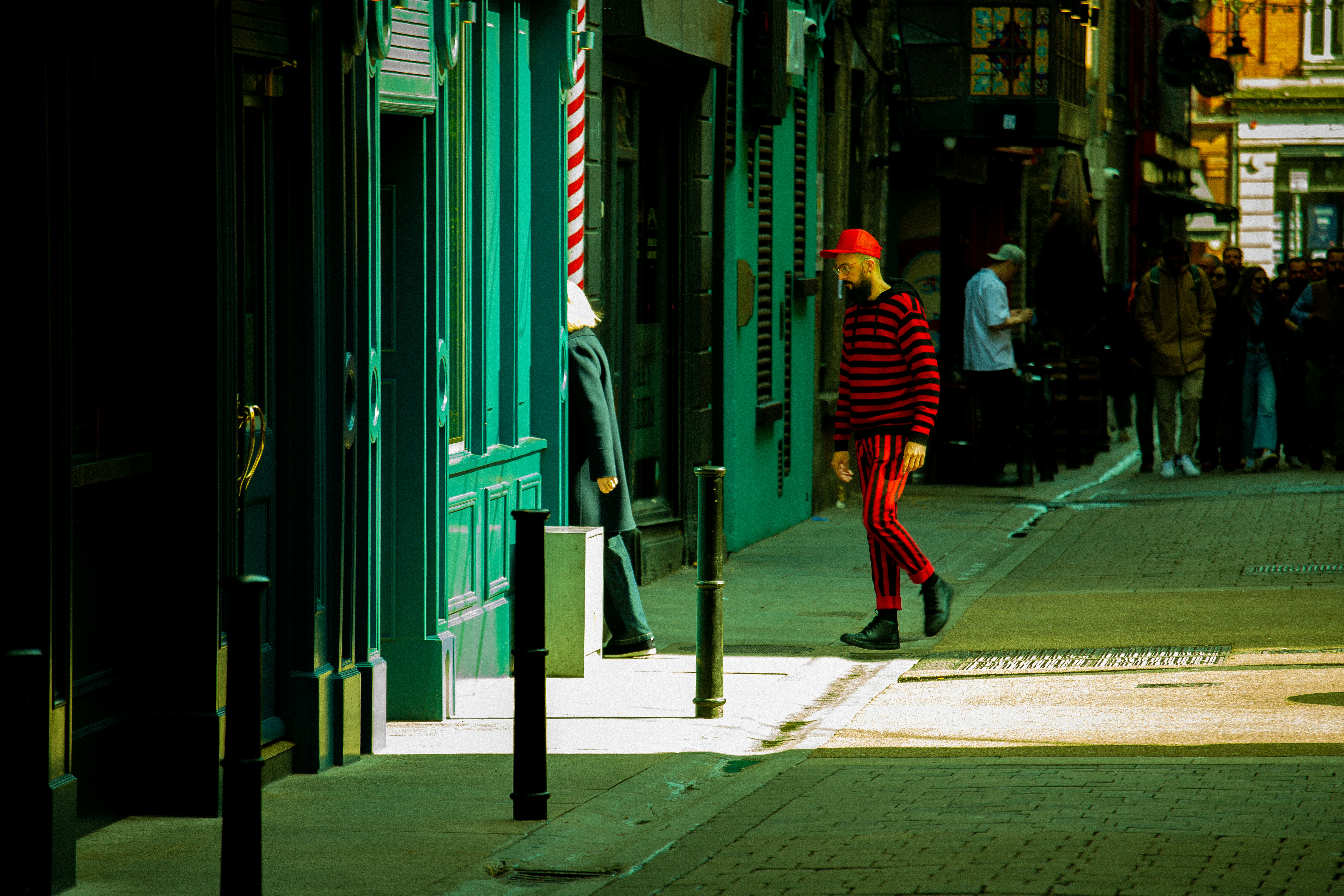 Striped Pedestrian in a Sunlit Alleyway